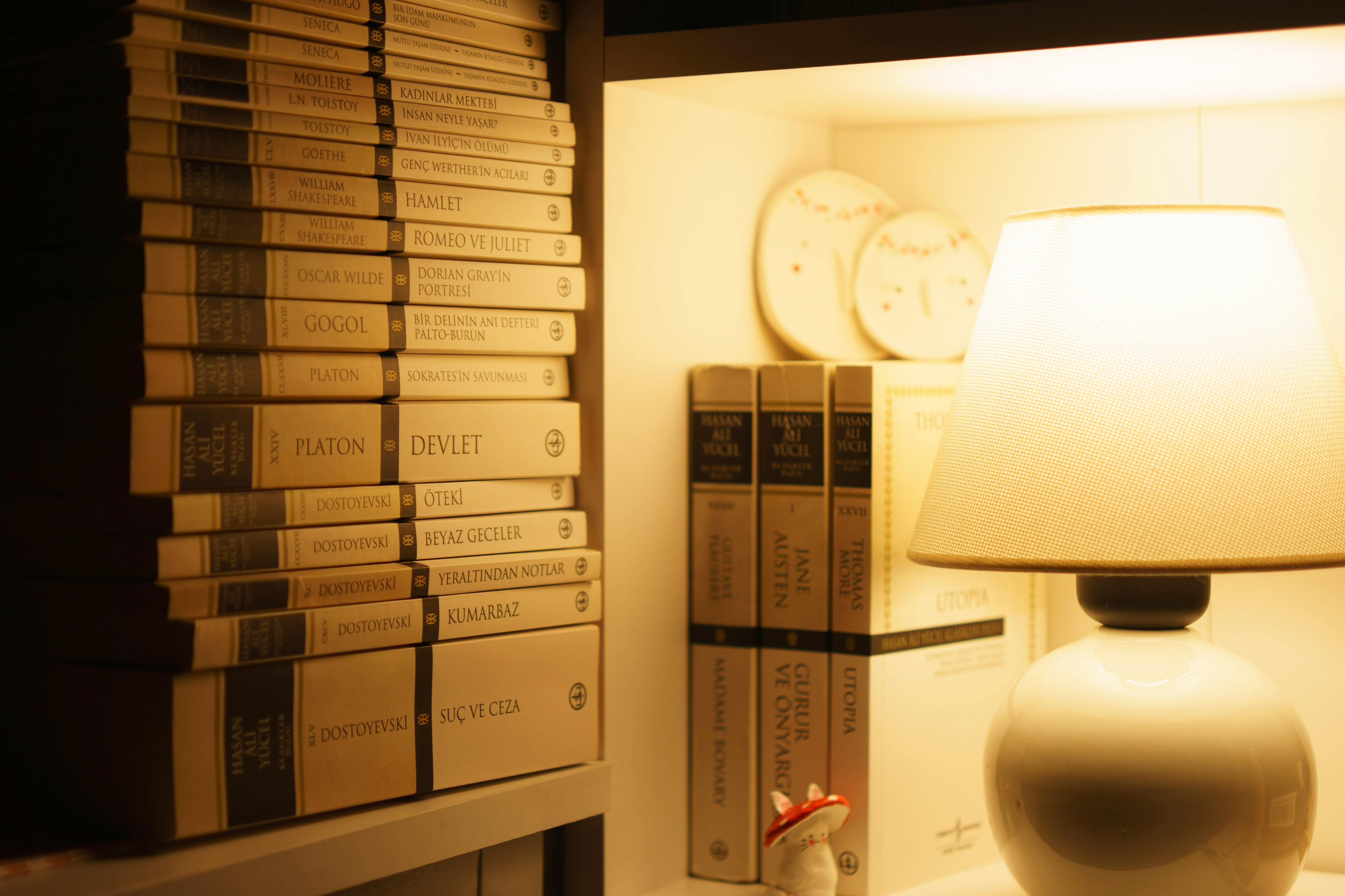 Cozy Bookshelf with Warm Lighting and Decor · Free Stock Photo