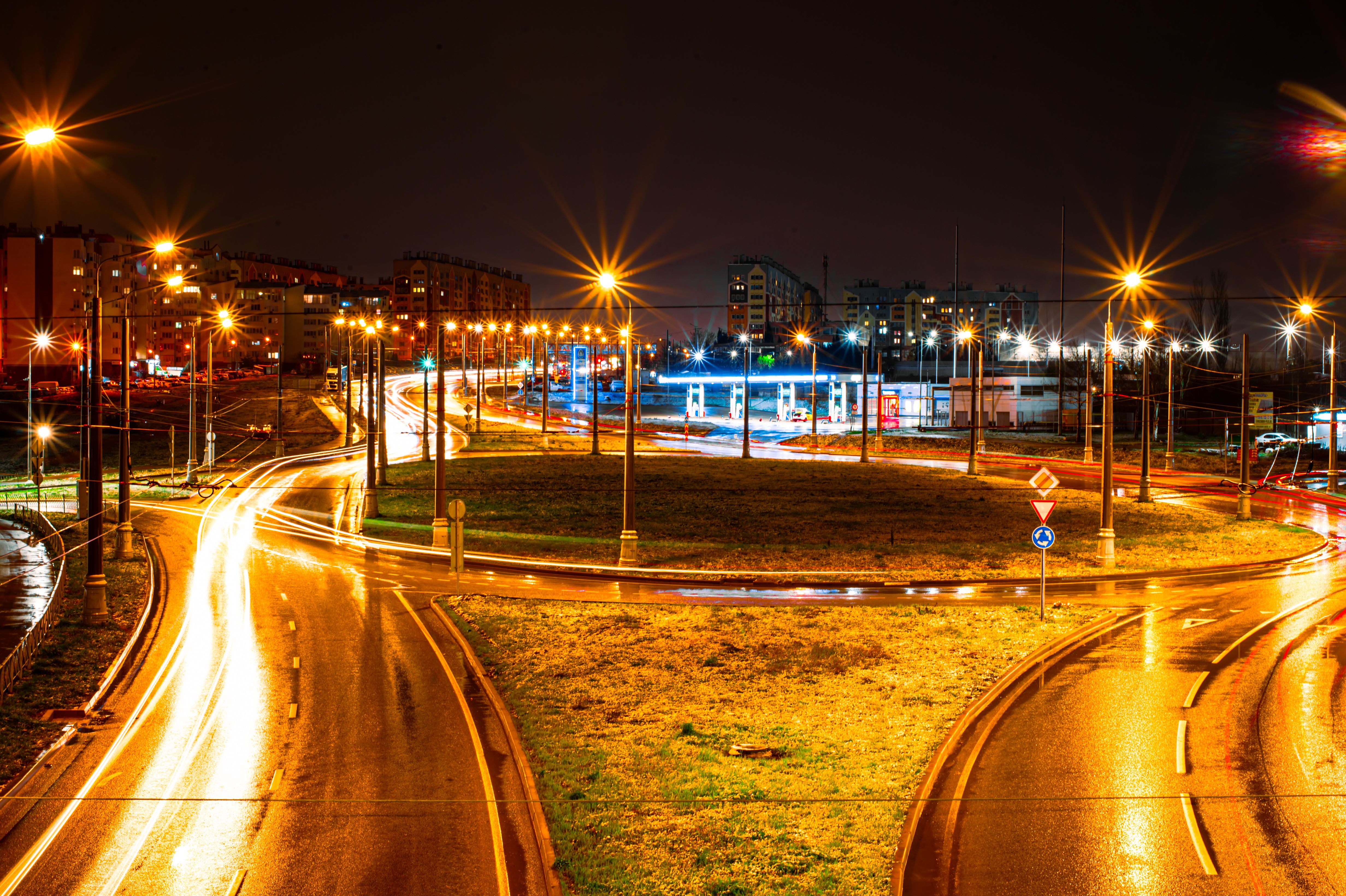 Vibrant Urban Roundabout at Night with Light Trails · Free Stock Photo