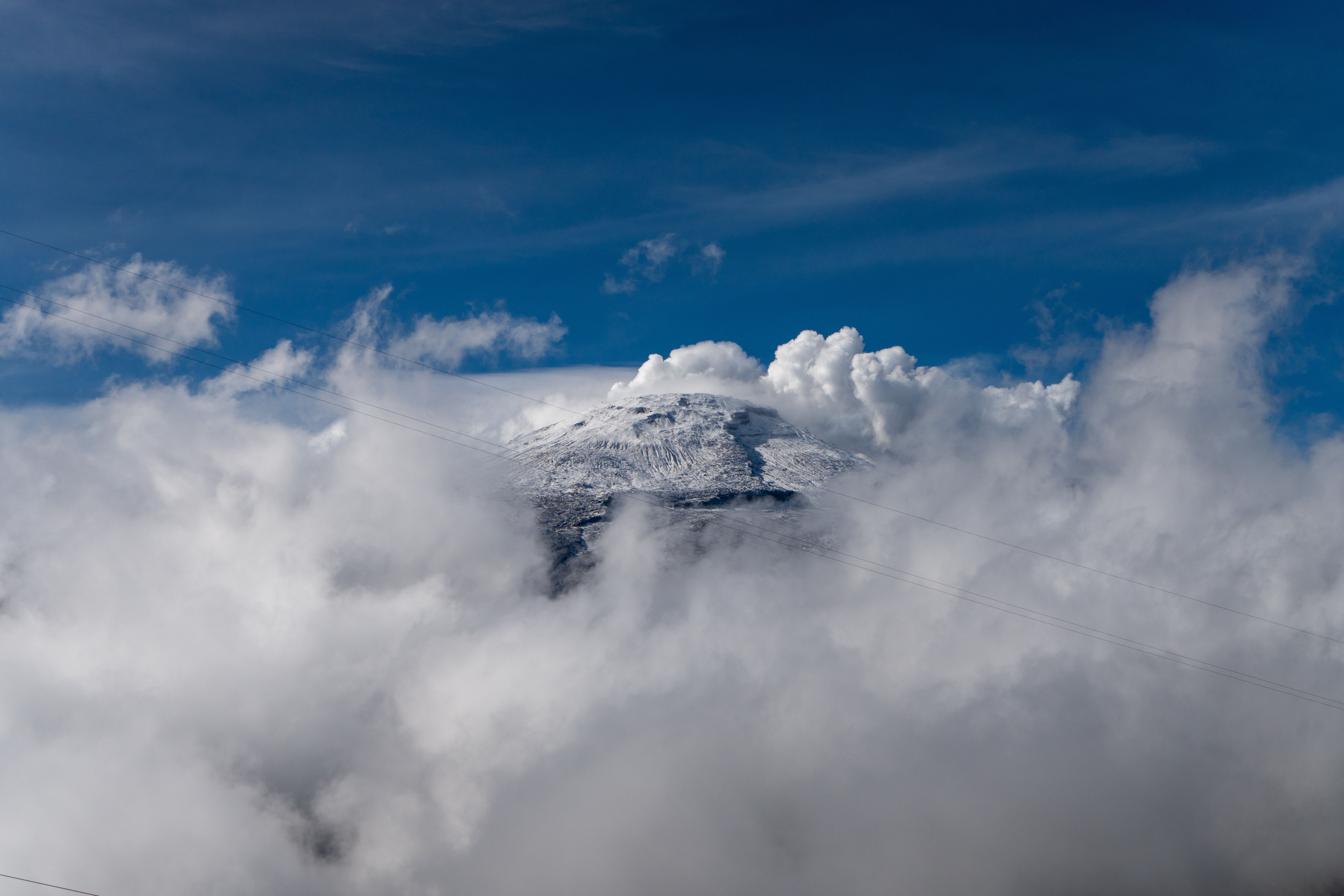 Snow-capped Mountain Emerging Through Clouds in Colombia · Free Stock Photo