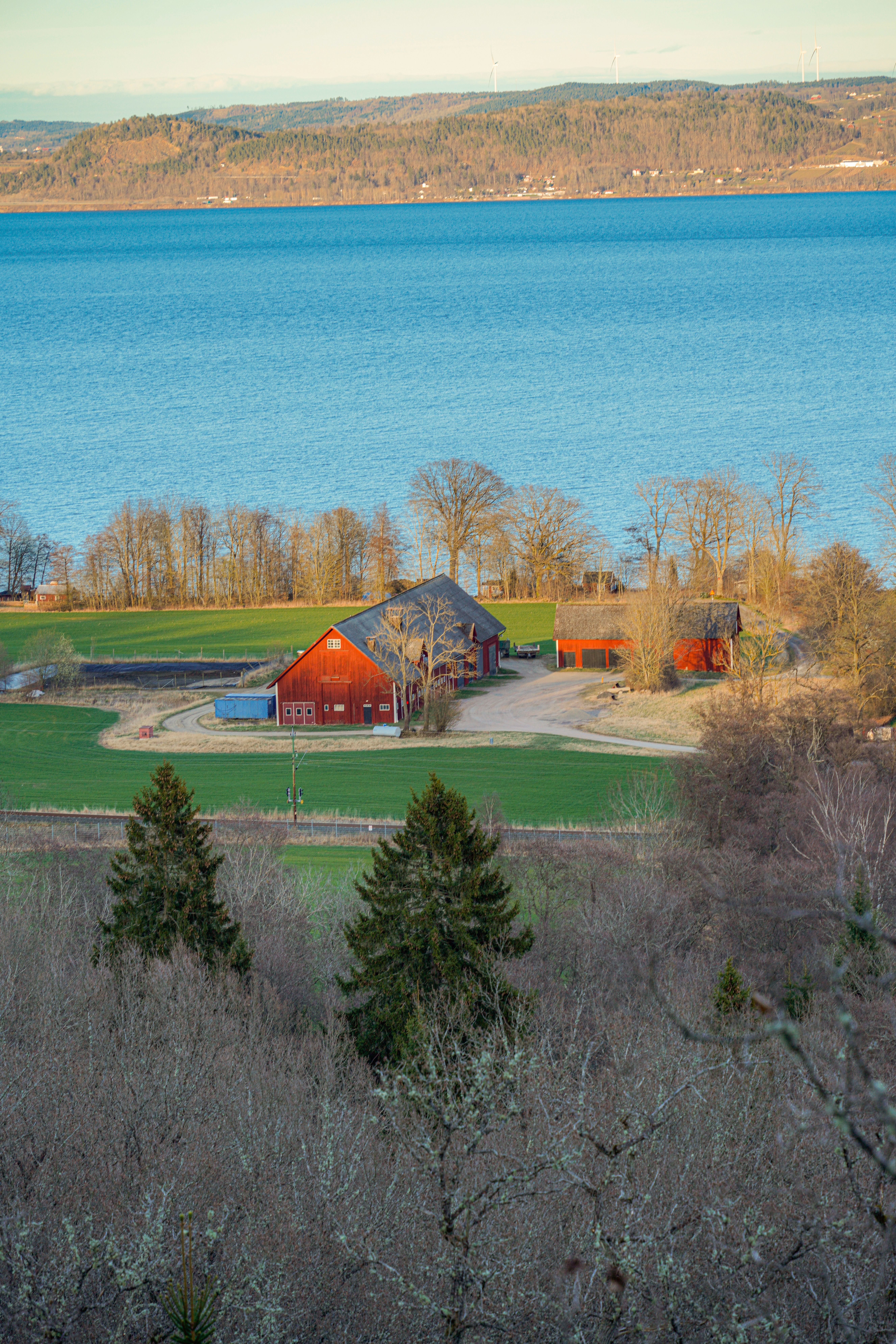 Scenic Nordic Farm by Blue Lake in Spring · Free Stock Photo
