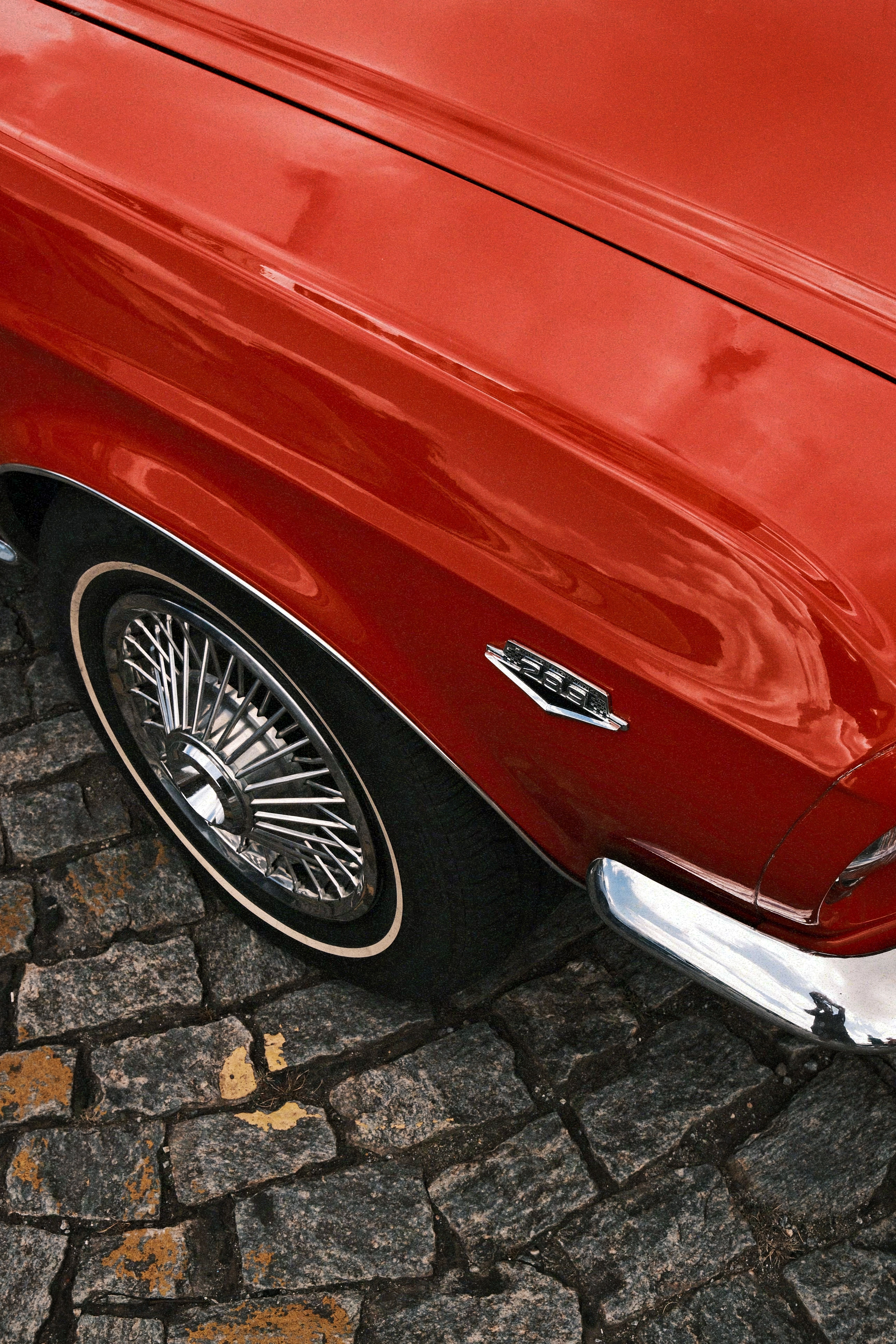 Red Vintage Car Wheel on Cobblestone Street · Free Stock Photo