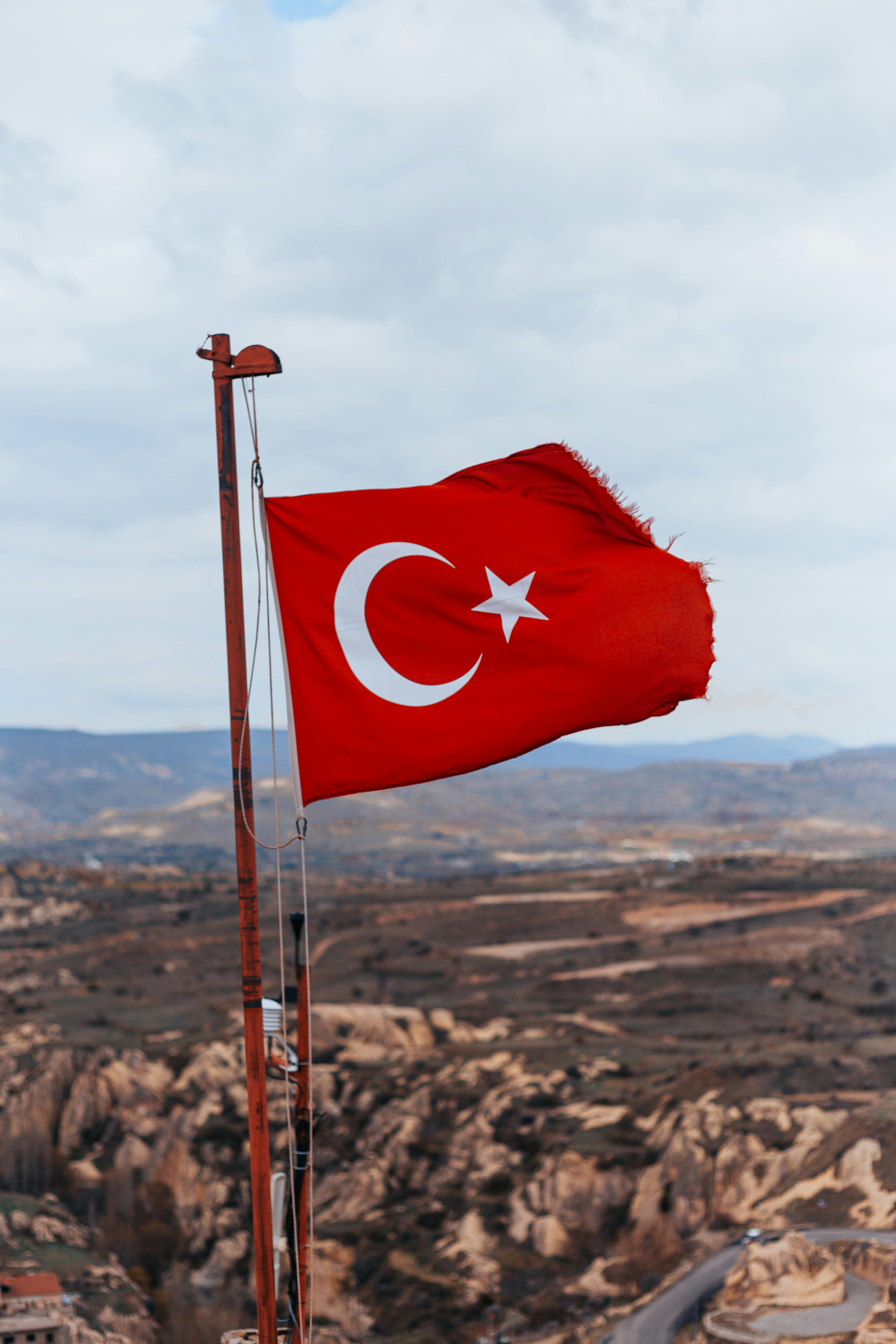 Turkish Flag Overlooking Cappadocia's Unique Landscape · Free Stock Photo