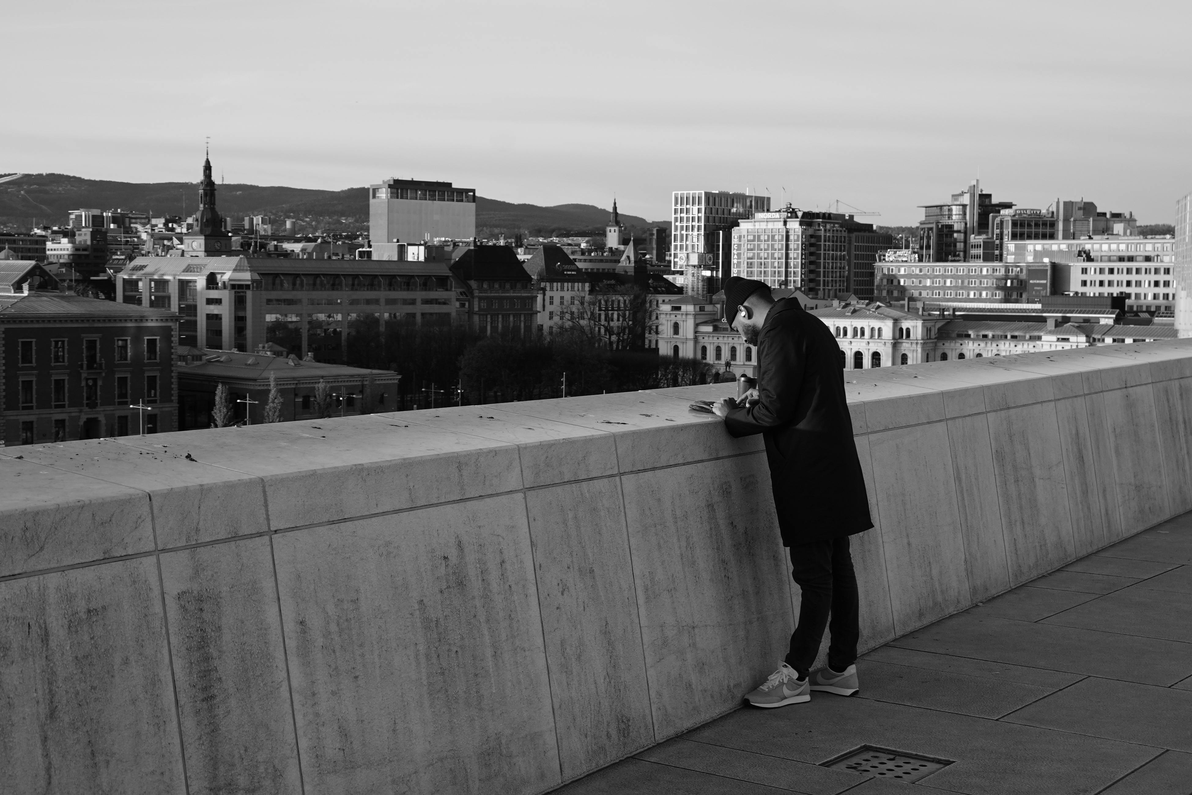 Contemplative Moment on Oslo Opera House Rooftop · Free Stock Photo