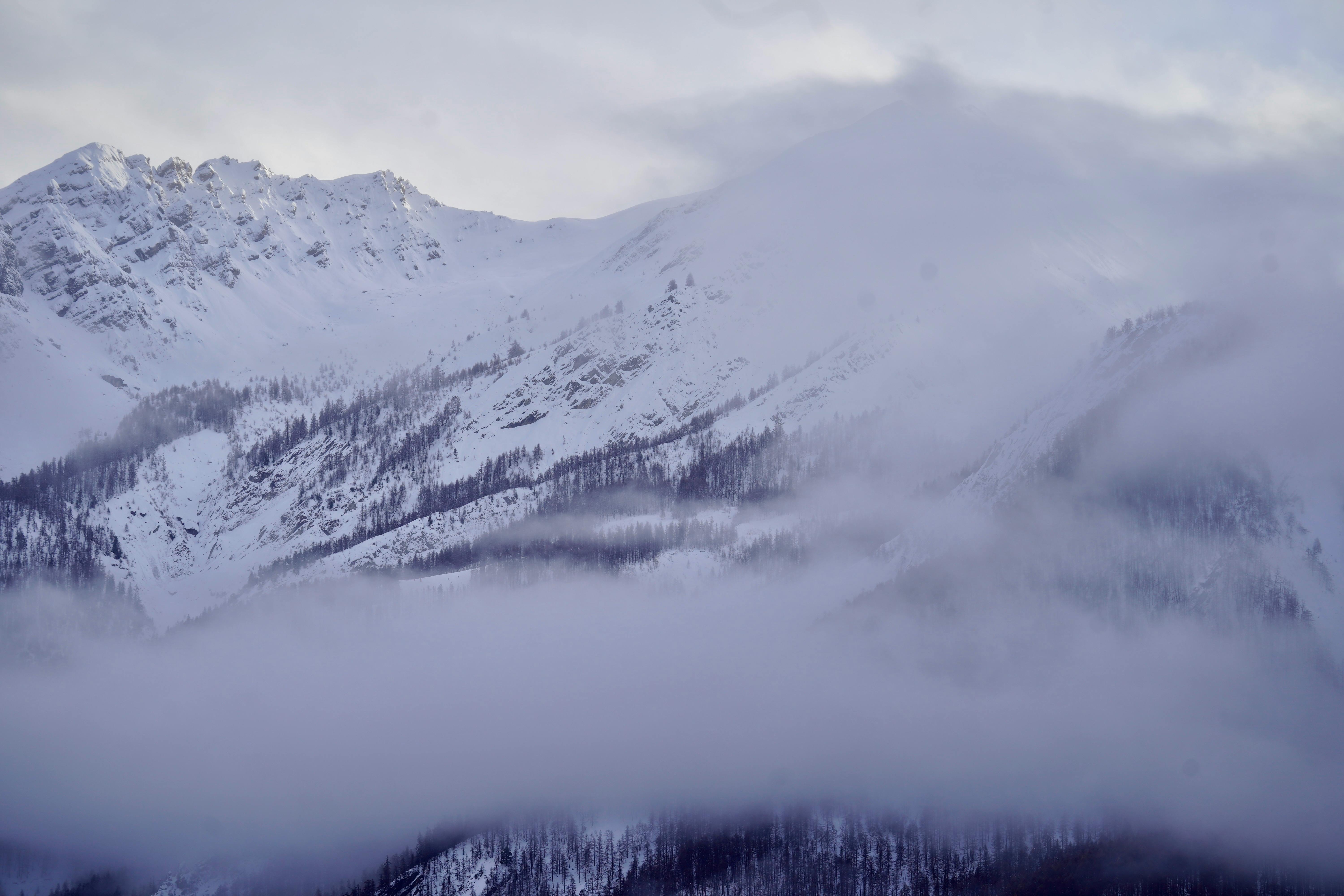 Snowy Mountain Peaks Shrouded in Mist · Free Stock Photo