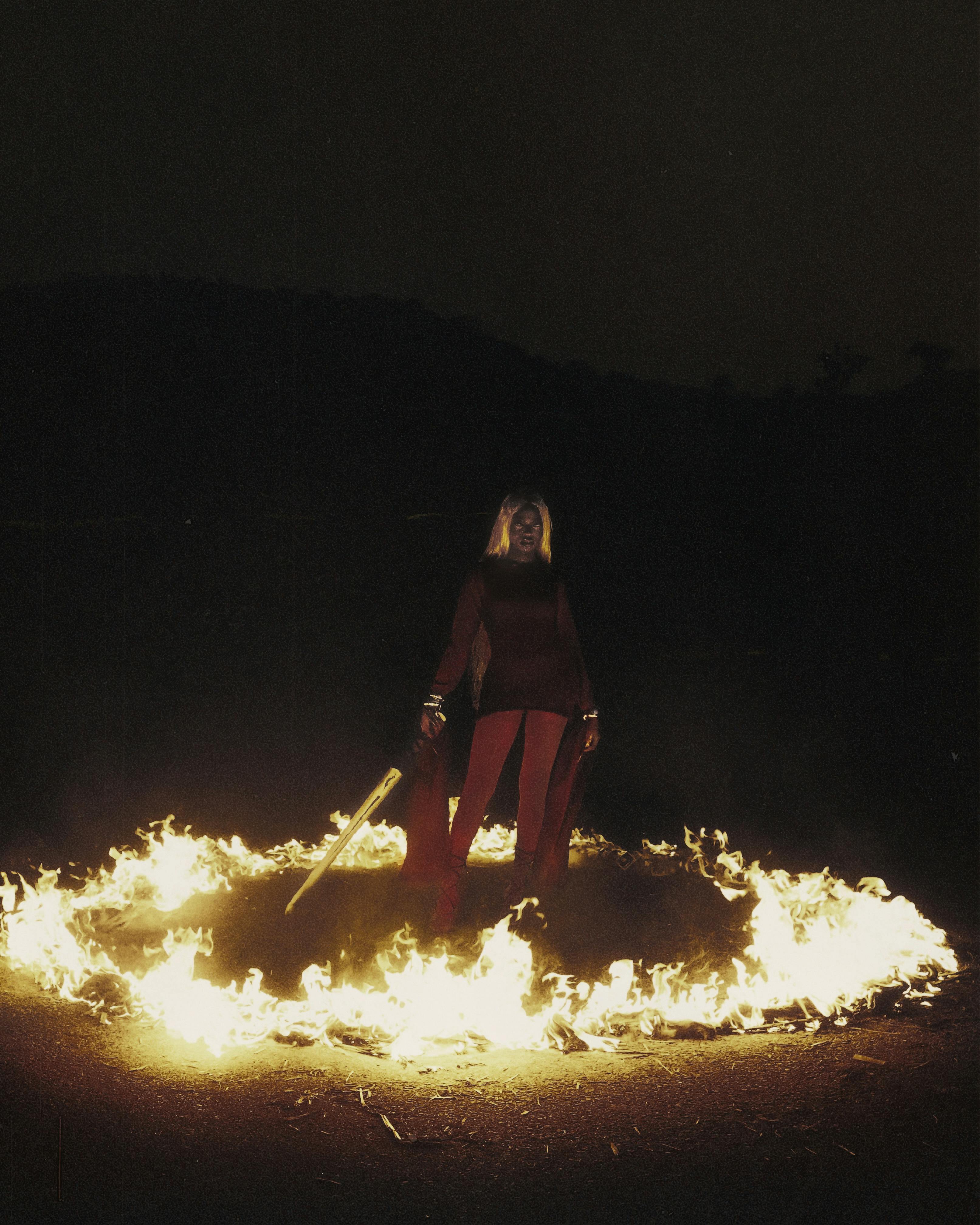 Dramatic Night Scene with Flames and Figure · Free Stock Photo