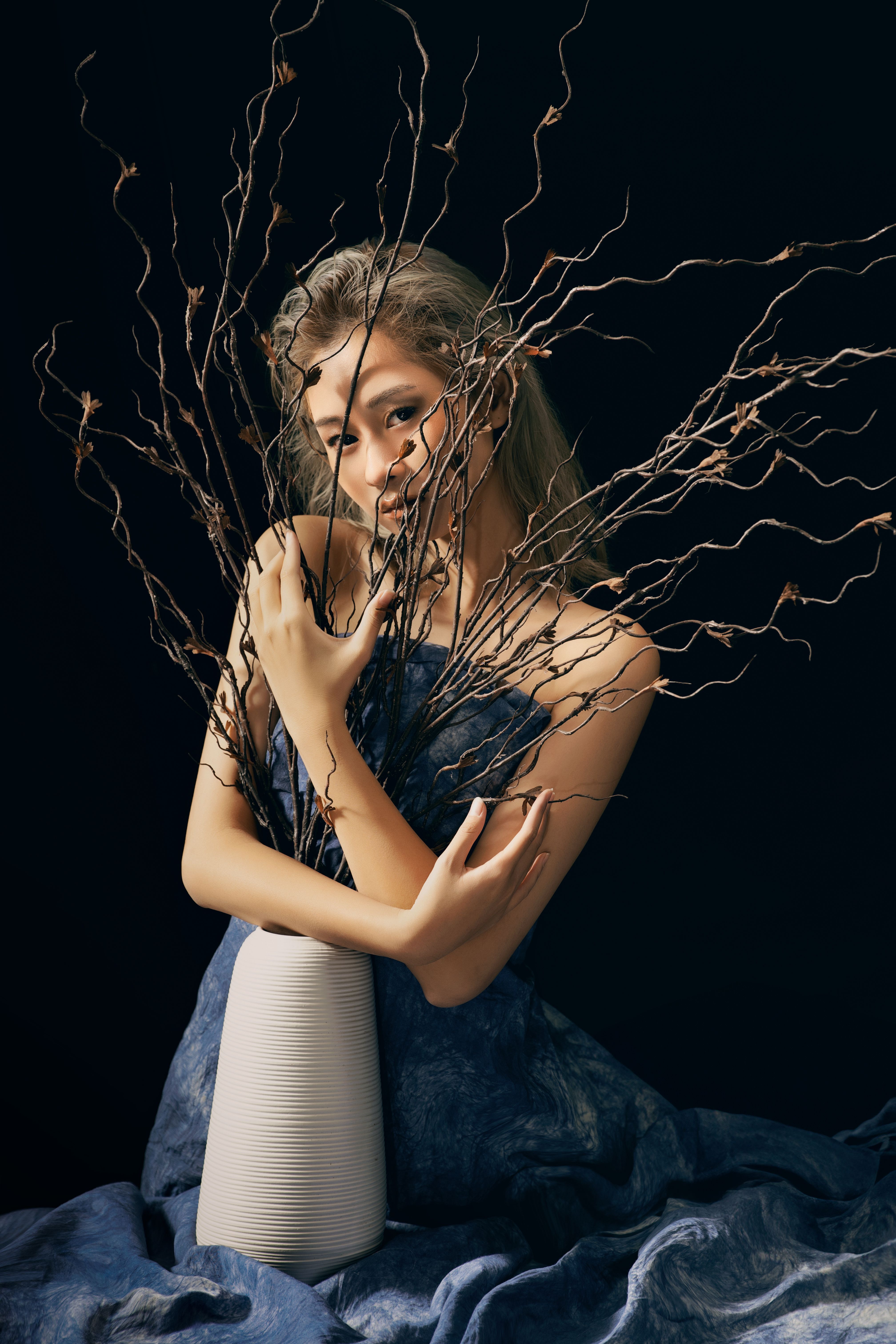 Artistic Portrait of Woman Embracing Twigs · Free Stock Photo