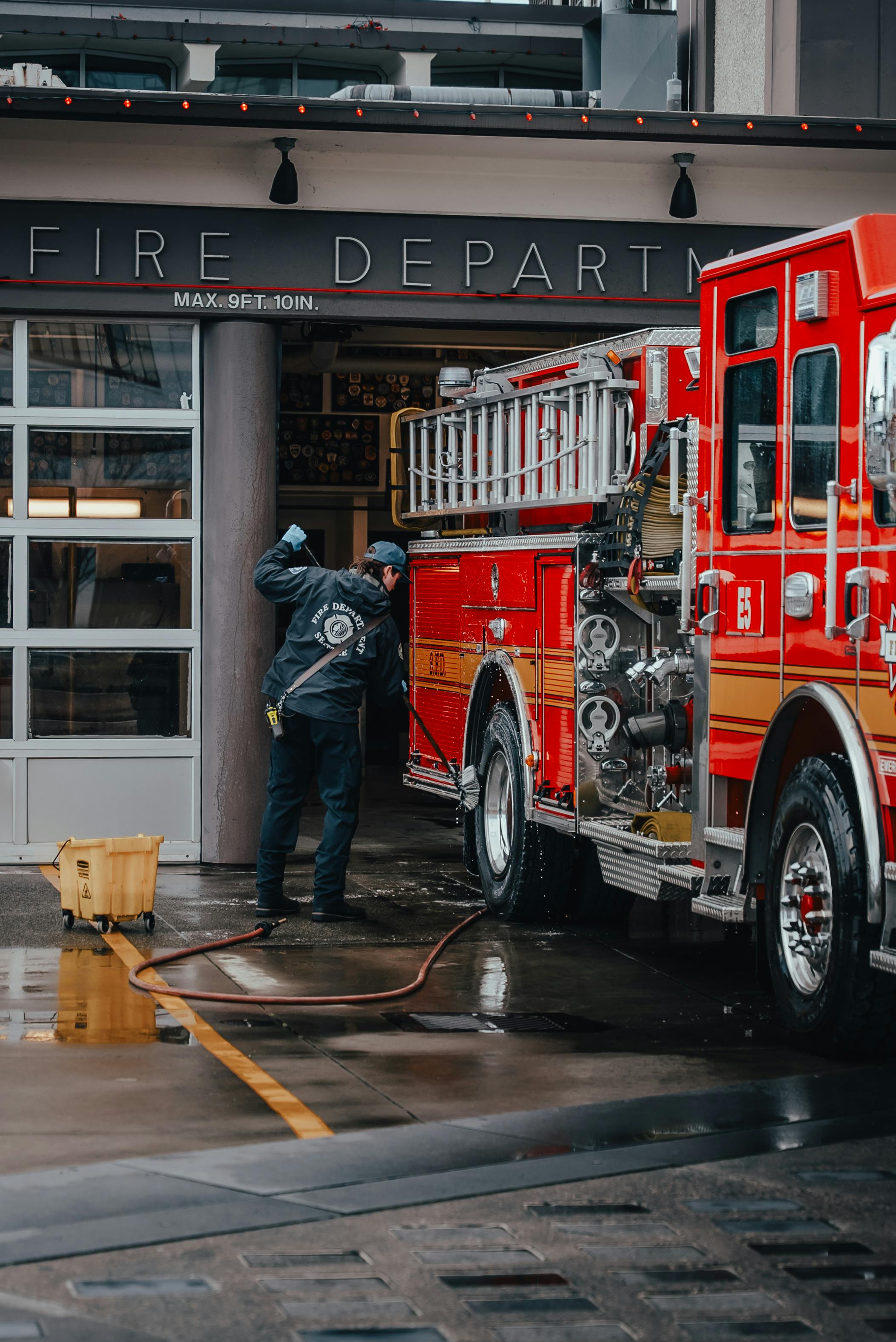 Firefighter Cleaning Truck at Seattle Fire Station · Free Stock Photo