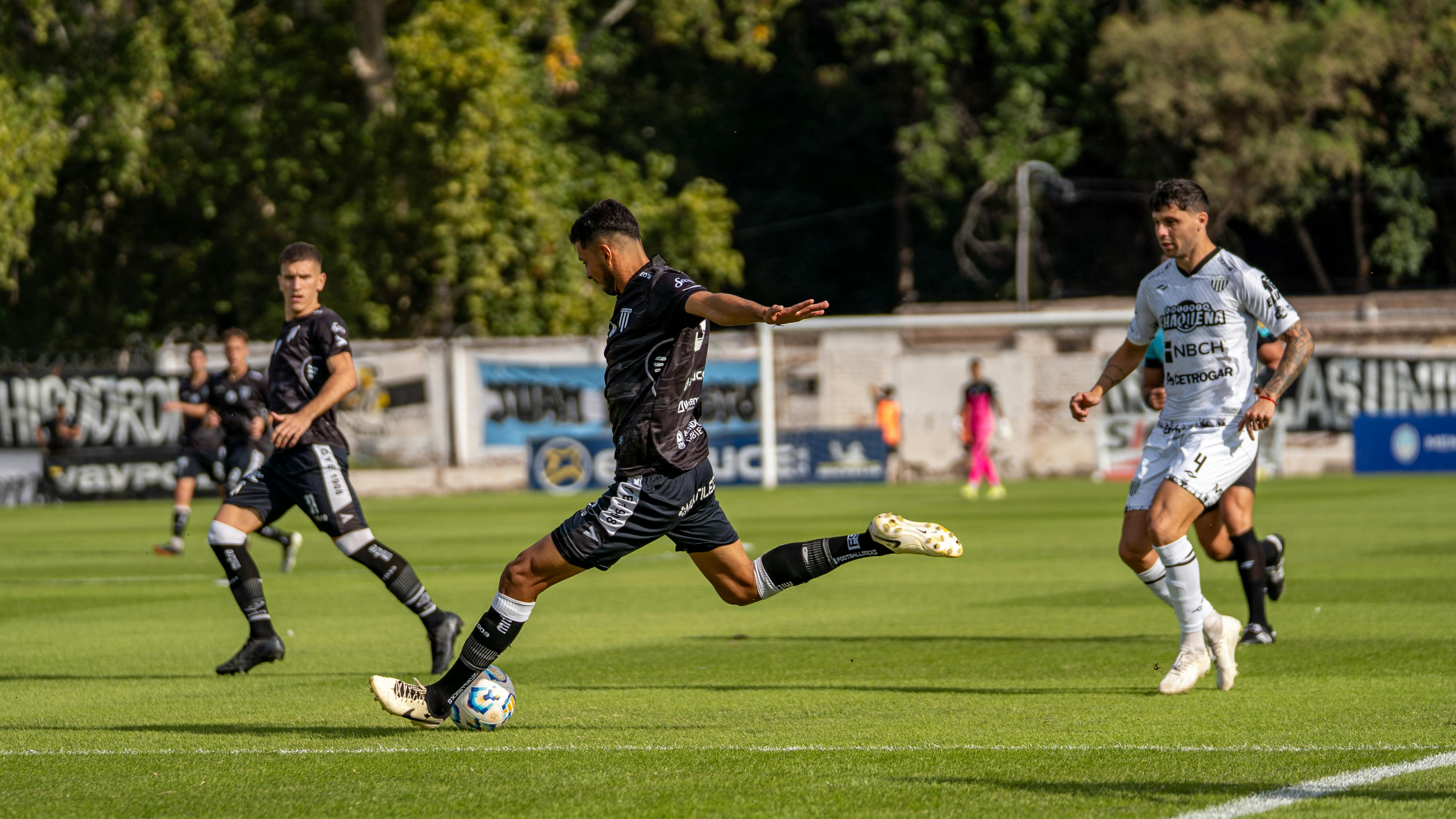 Dynamic Football Match Action Shot on Field · Free Stock Photo