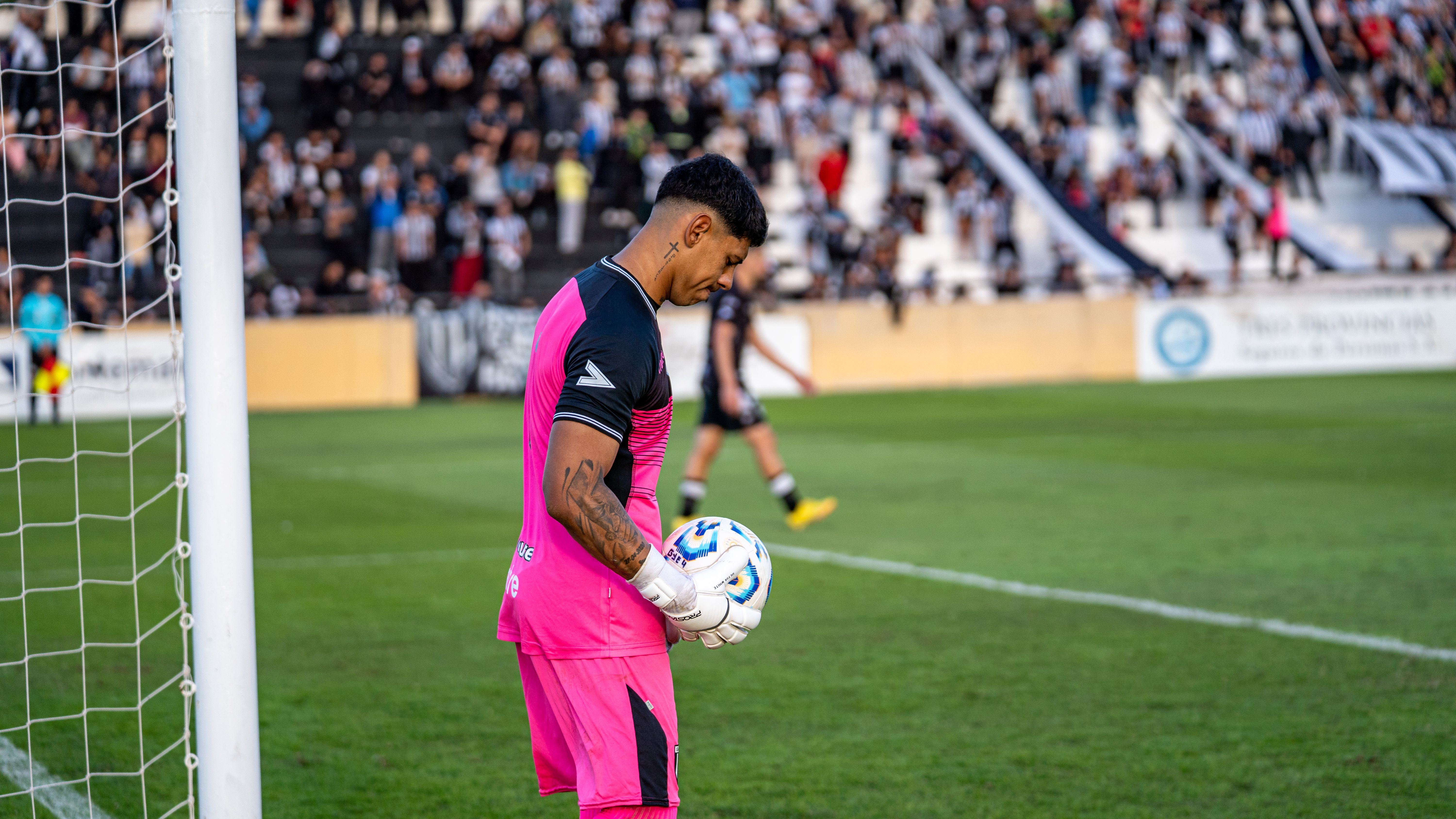 Goalkeeper Prepares to Defend in Stadium Crowd · Free Stock Photo