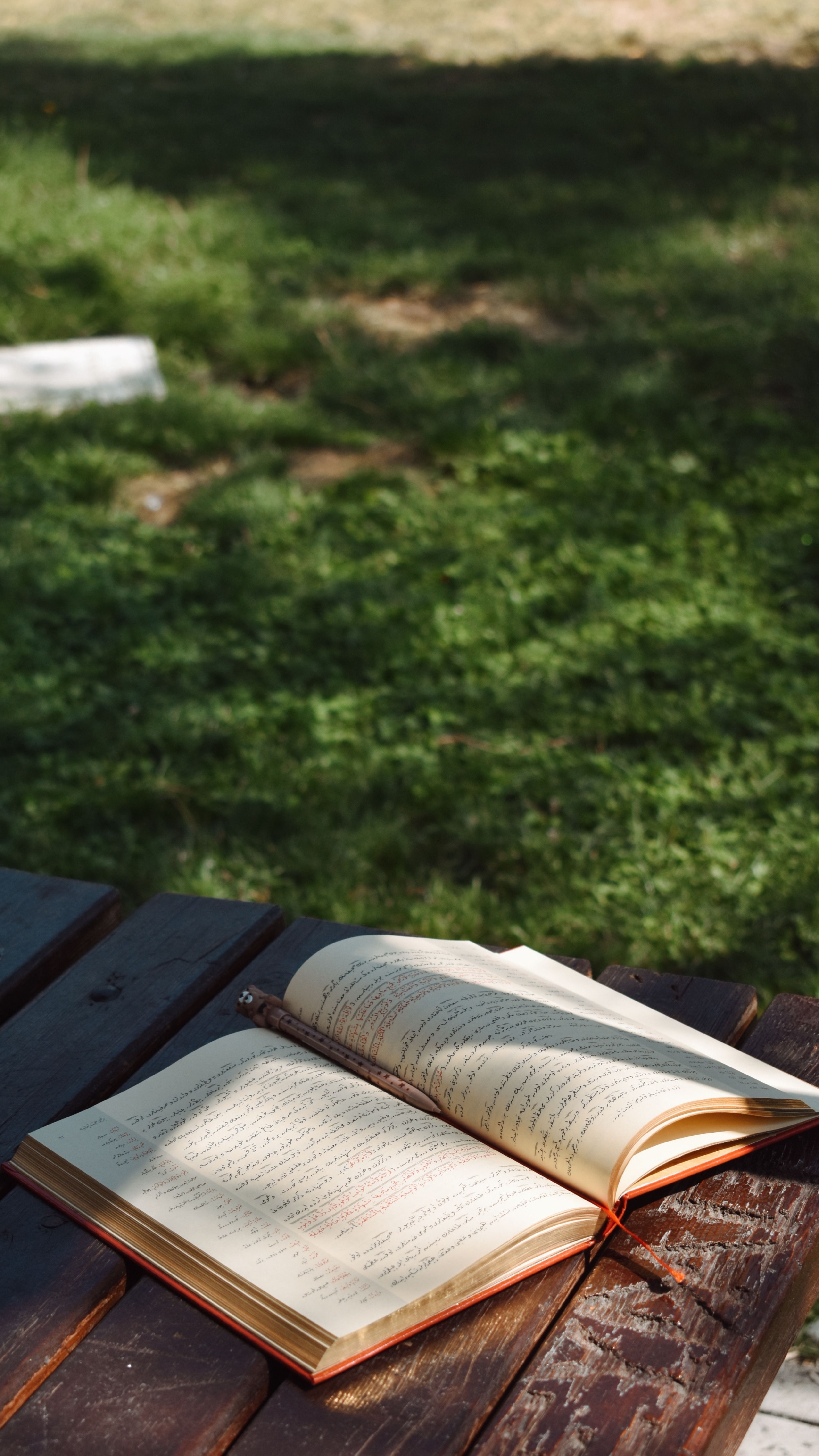 Open Notebook on Rustic Wooden Table Outdoors · Free Stock Photo