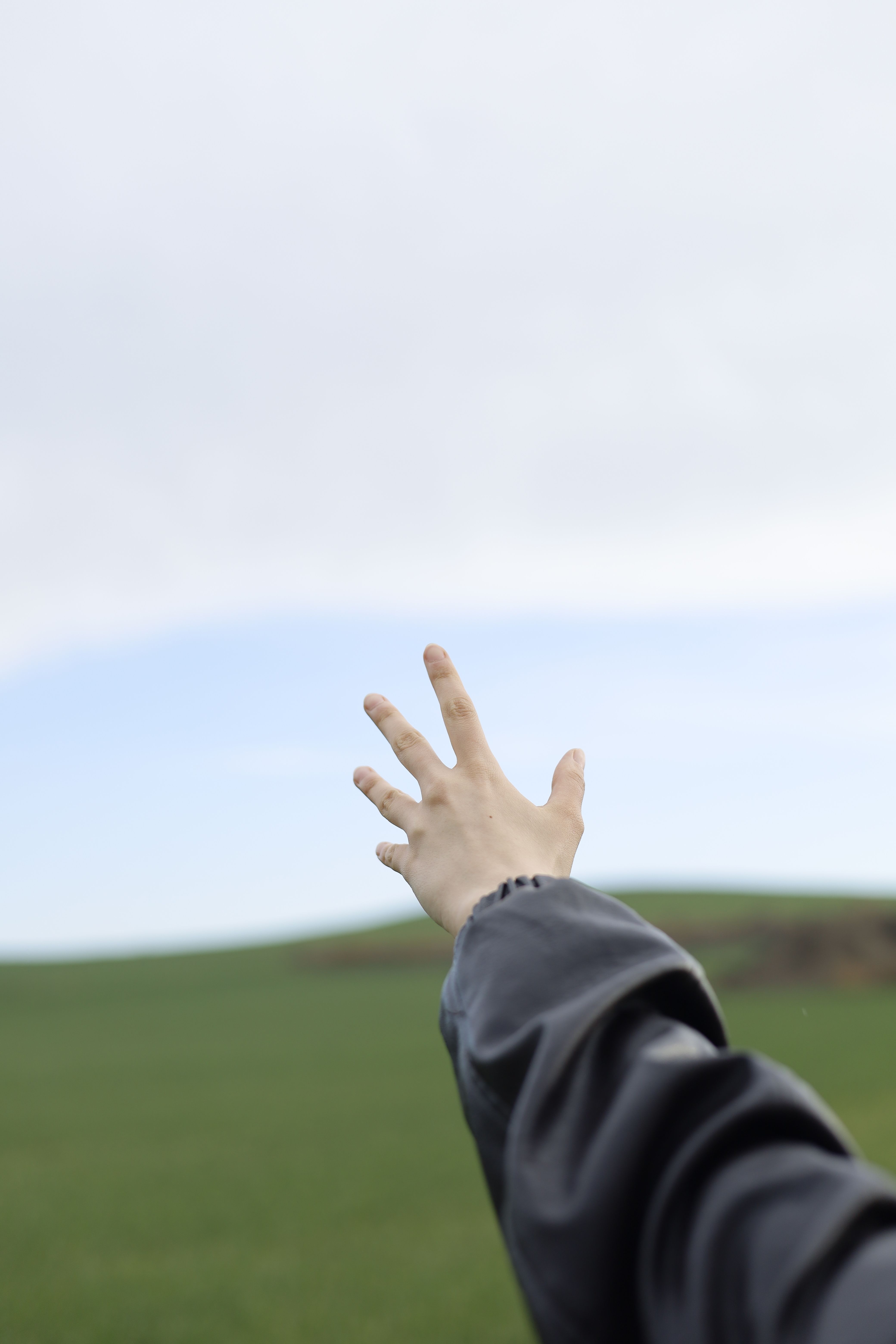Outstretched Hand Reaching Towards Blue Sky · Free Stock Photo
