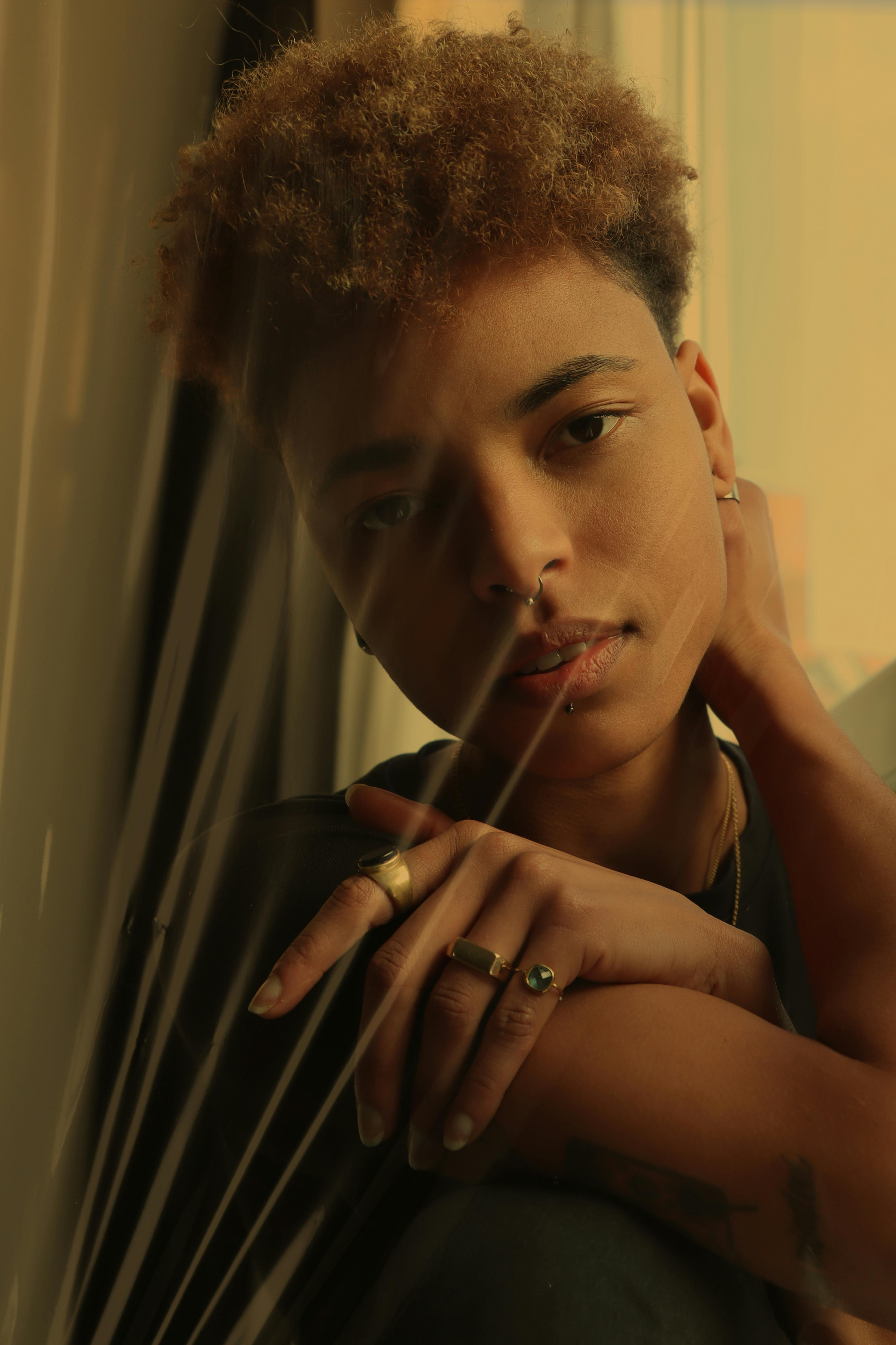 Contemplative Portrait through Reflective Glass · Free Stock Photo