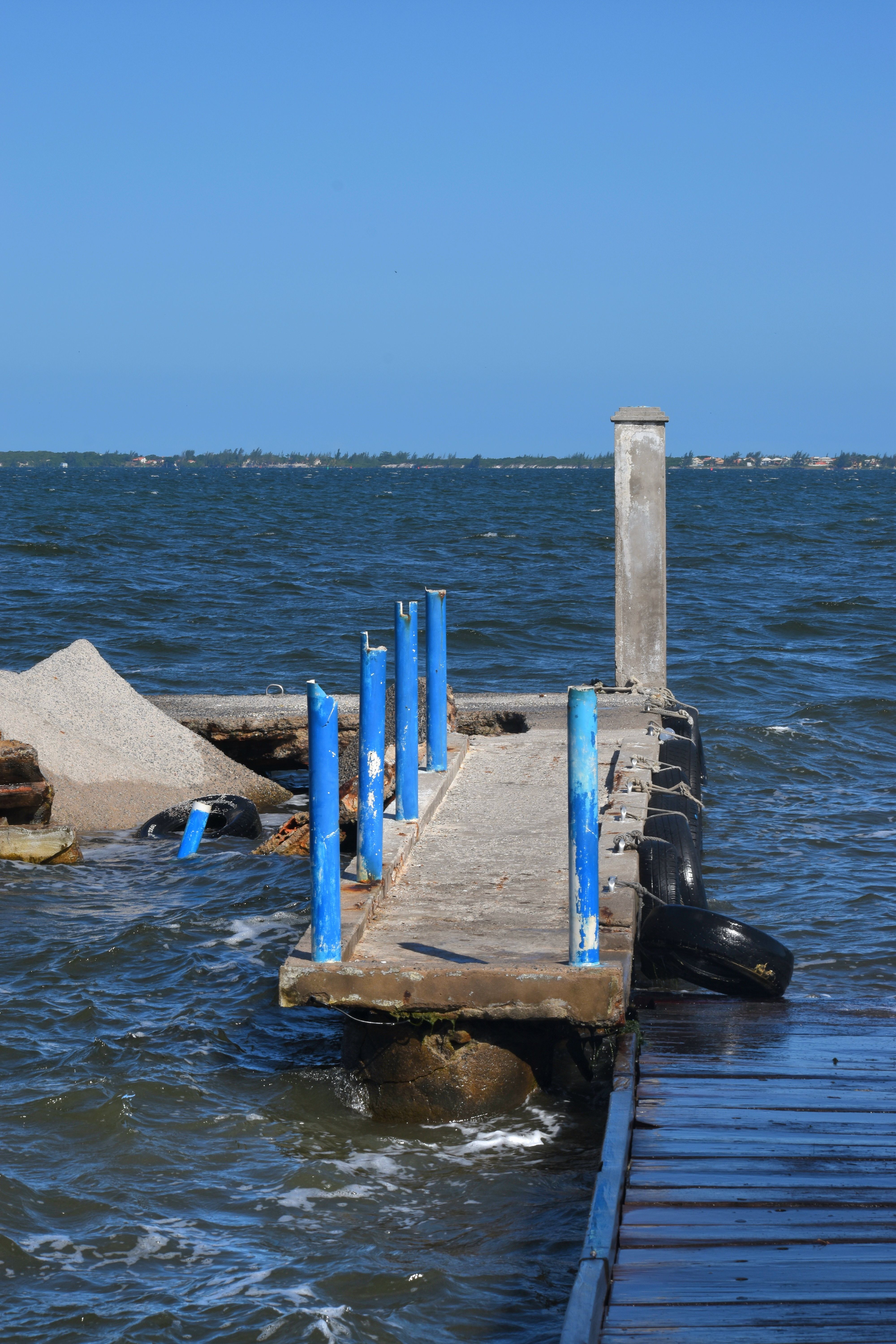 Old Pier Stretching into Blue Ocean Water · Free Stock Photo