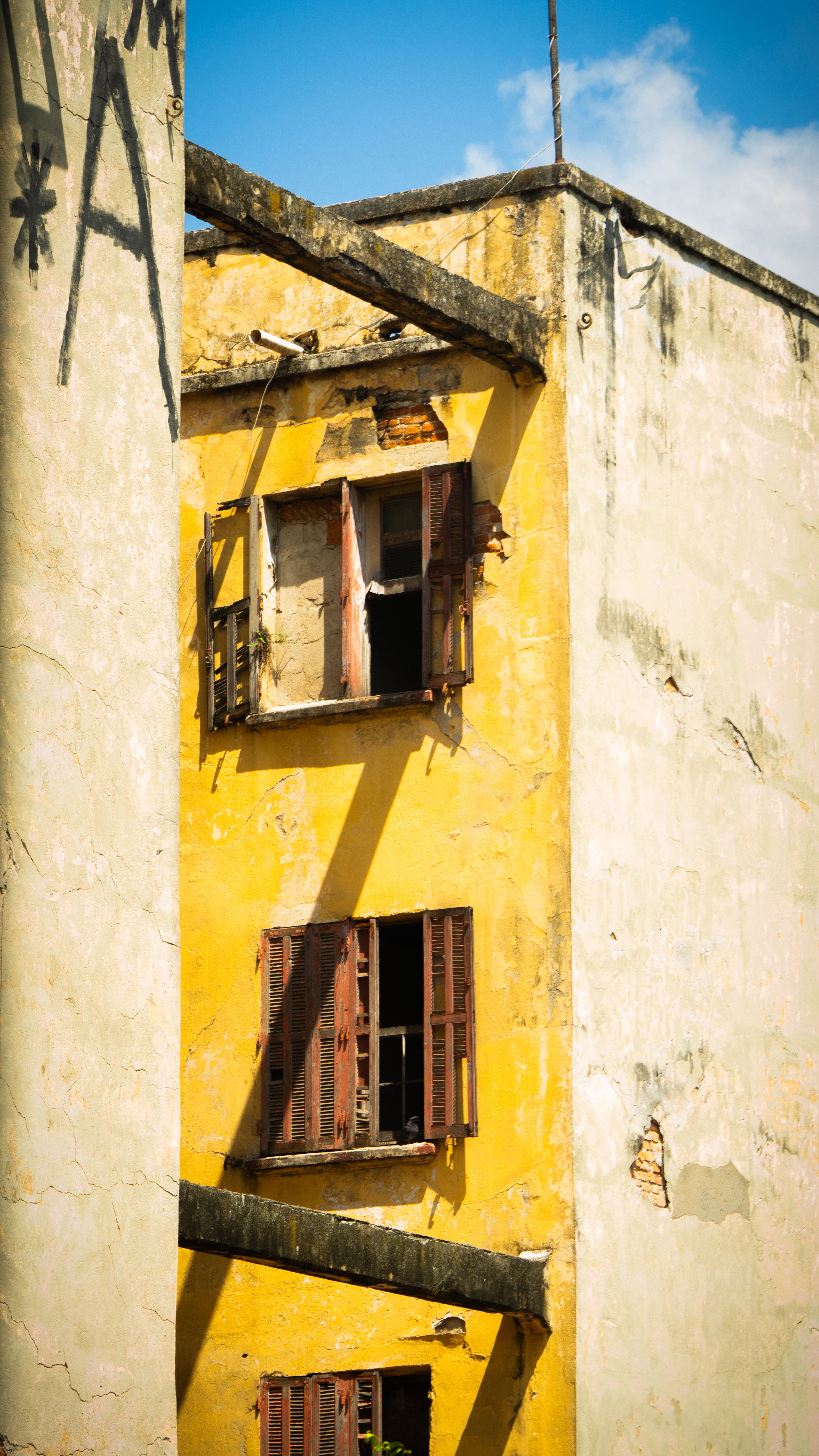 Old Yellow Building with Weathered Windows · Free Stock Photo