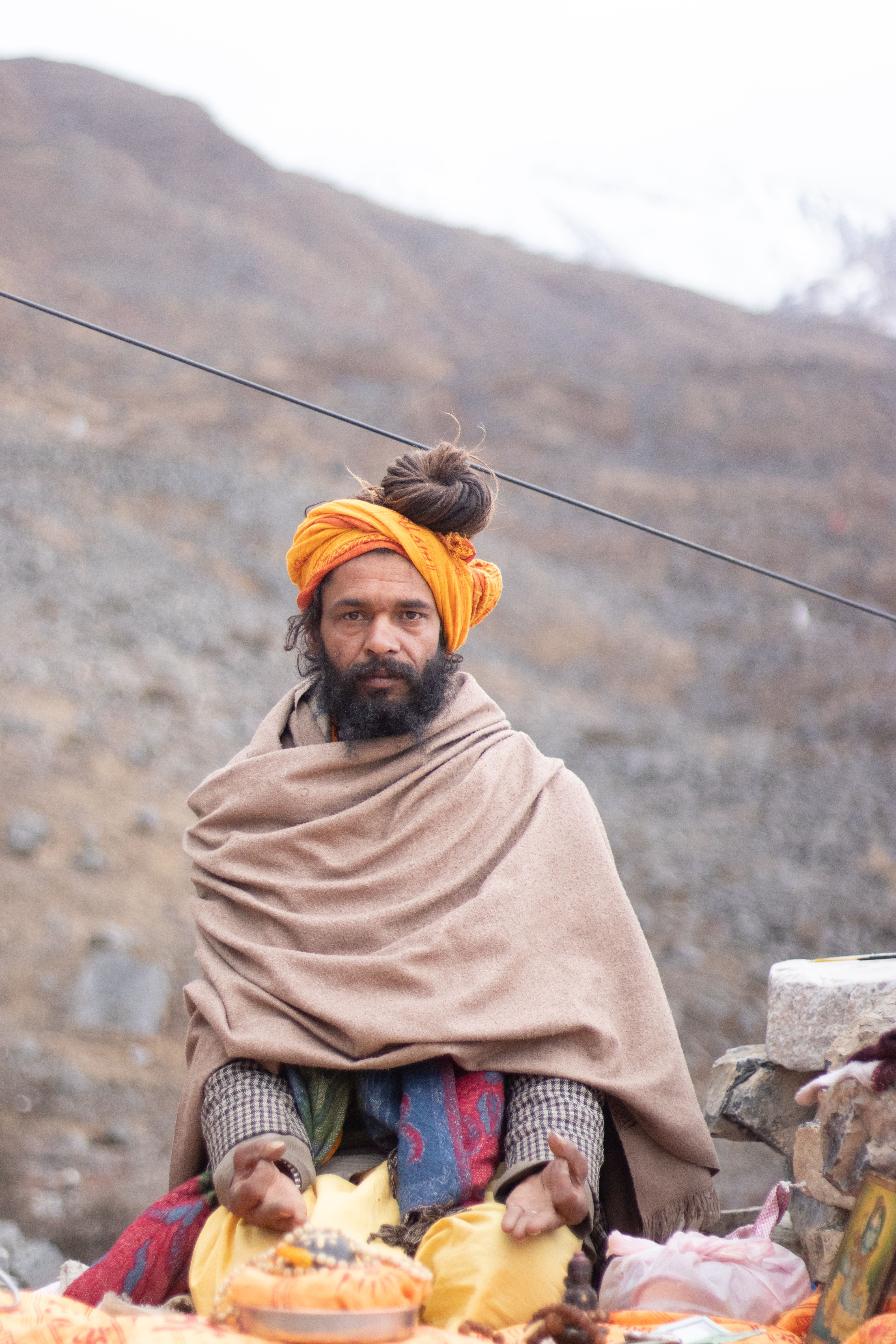 Portrait of a Sadhu in Rugged Mountainous Terrain · Free Stock Photo