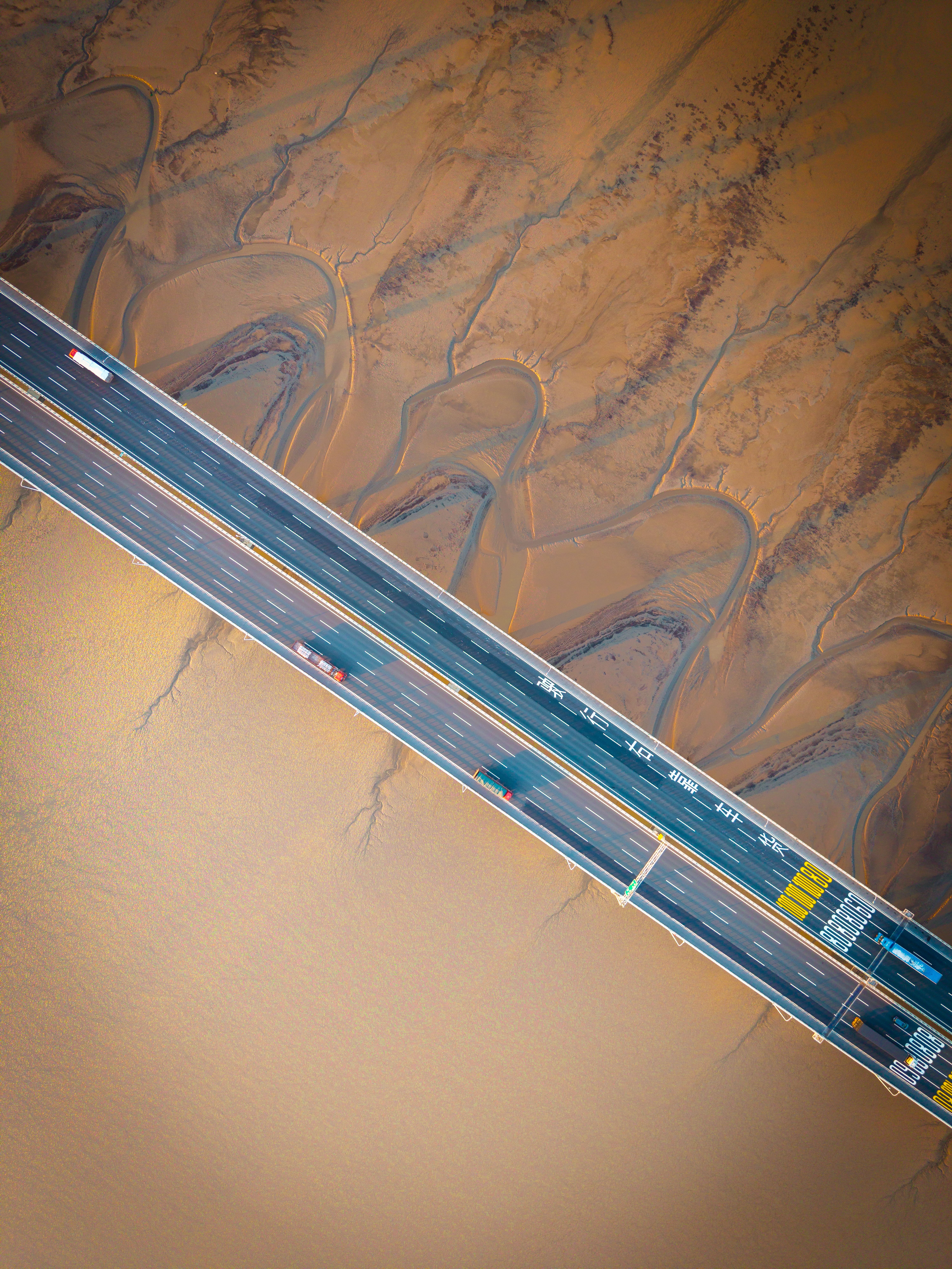 Aerial View of Bridge Over Muddy River Delta · Free Stock Photo