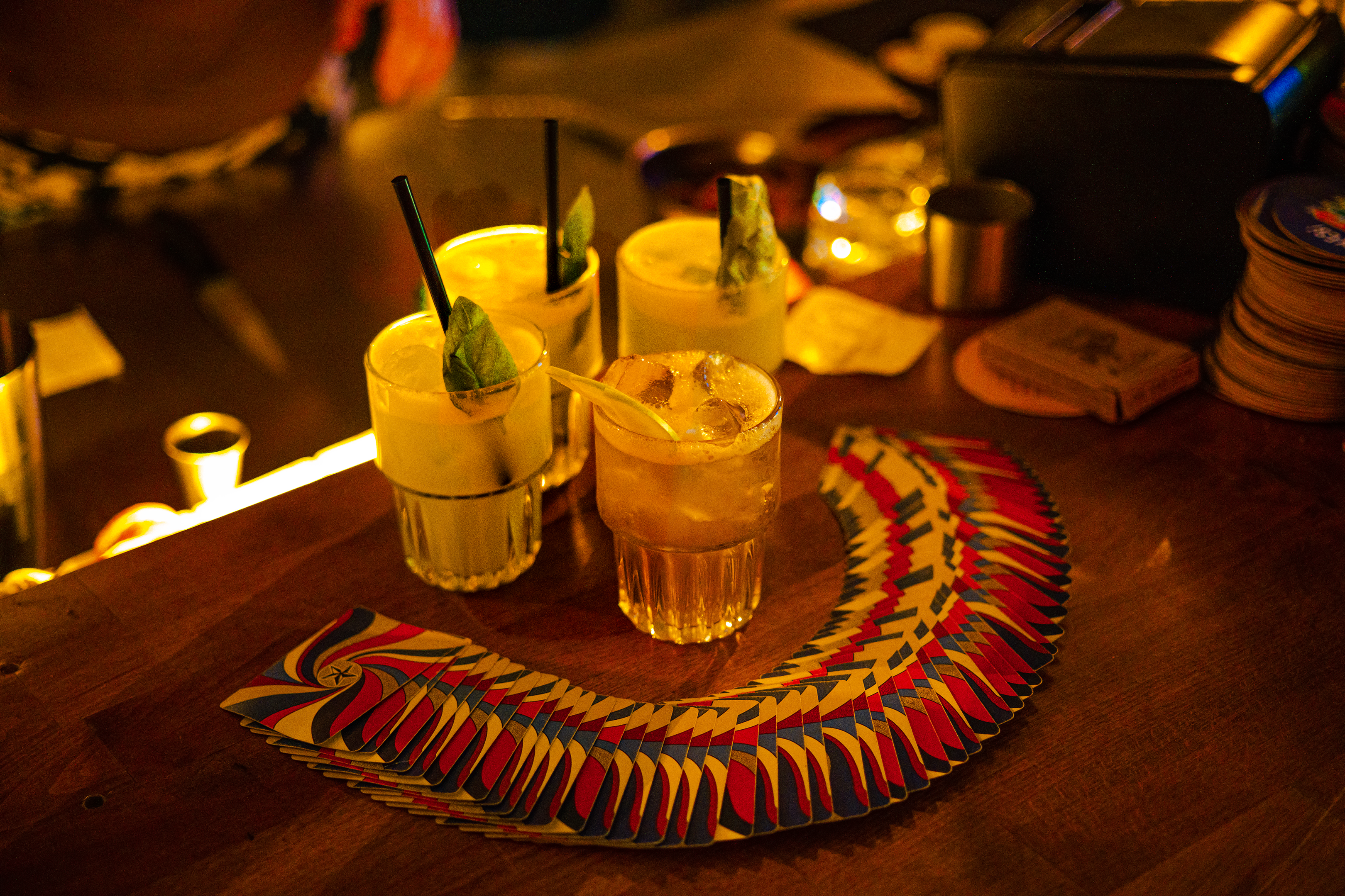 Vibrant Cocktails and Playing Cards at Dimly Lit Bar · Free Stock Photo