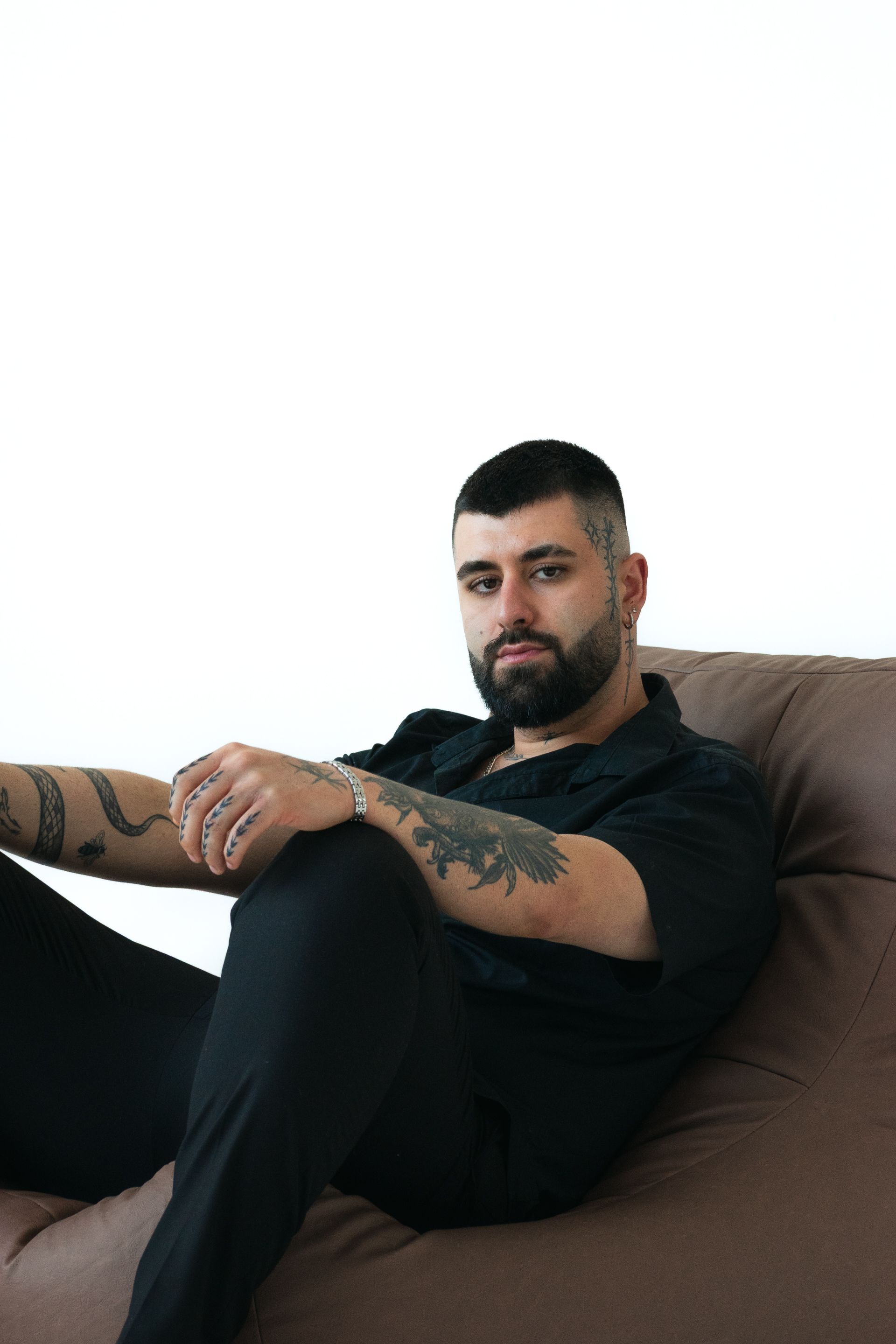 Relaxed Portrait of Tattooed Man in Studio · Free Stock Photo