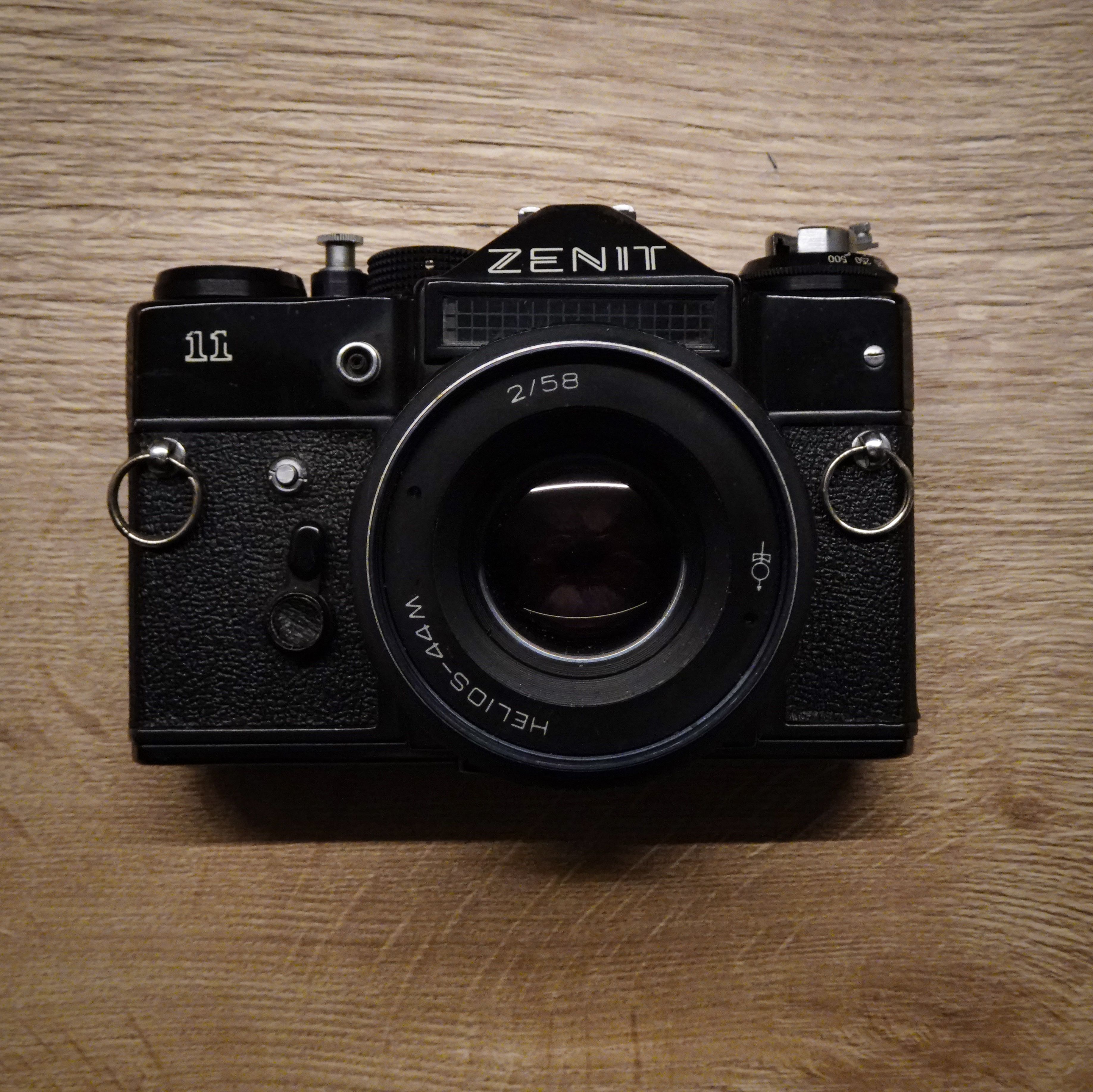 Vintage Zenit 11 Camera on Wooden Surface · Free Stock Photo