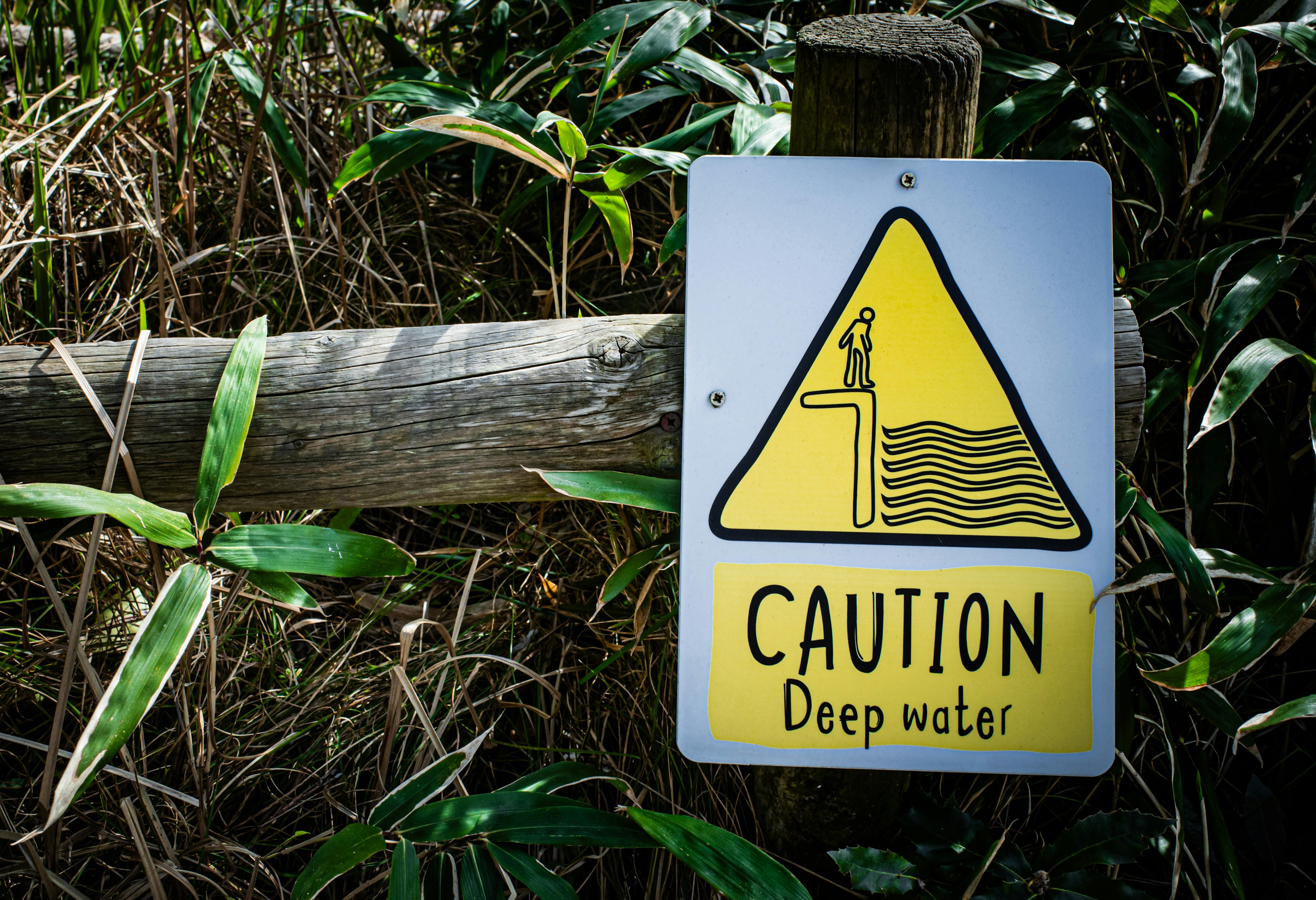 Caution Deep Water Sign in Natural Setting · Free Stock Photo