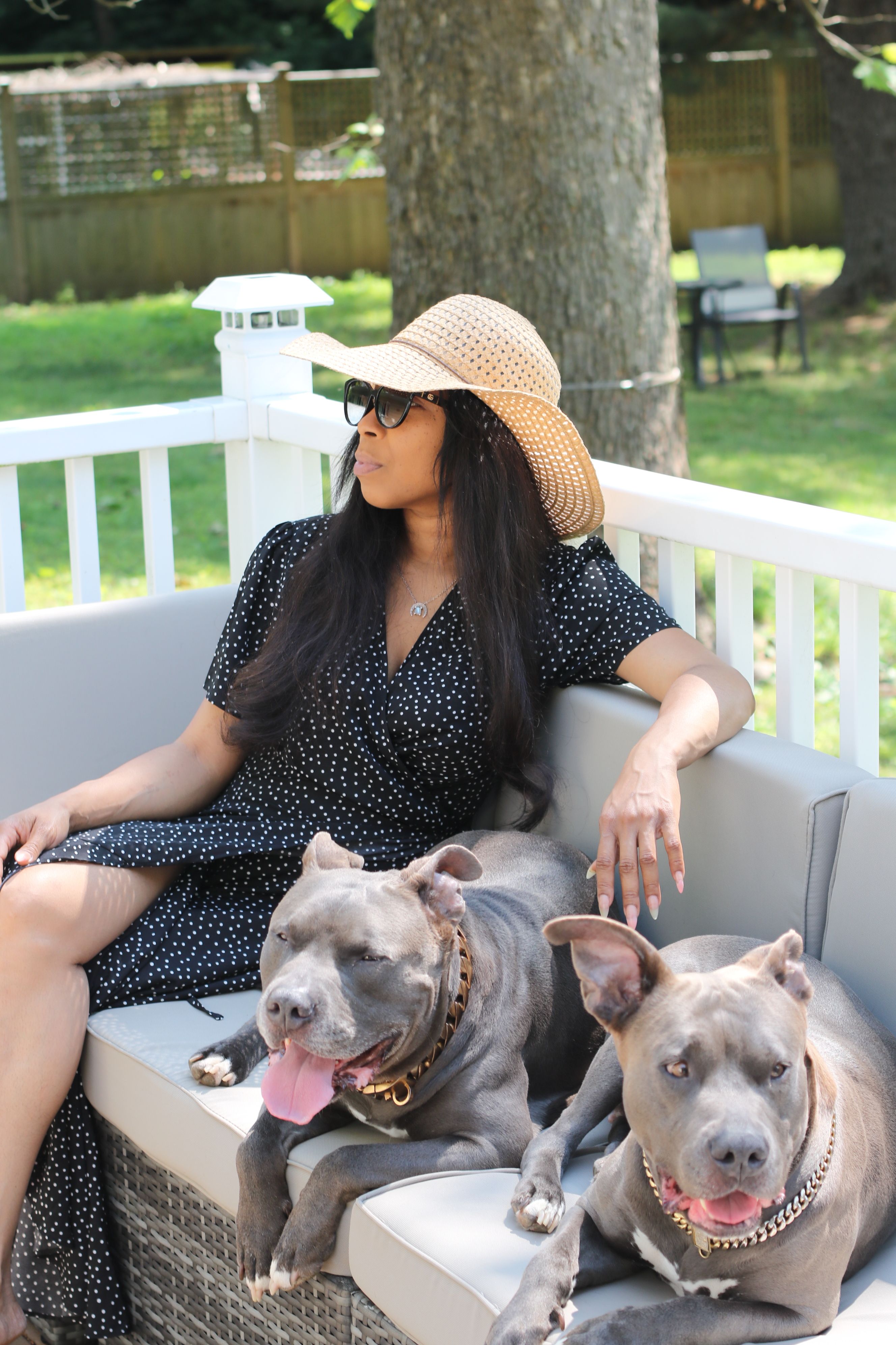 Woman Relaxing with Dogs on Outdoor Patio · Free Stock Photo
