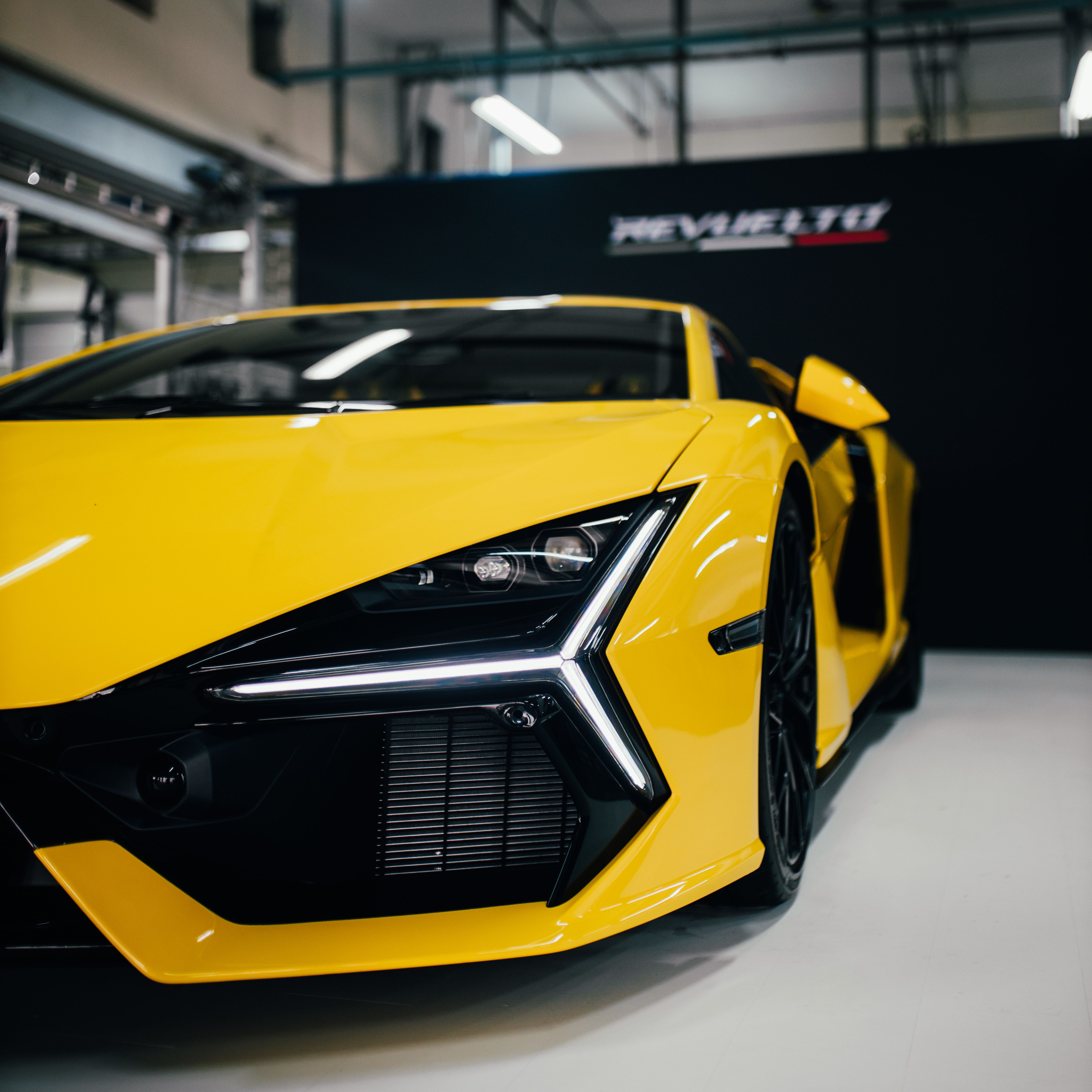 Yellow Lamborghini Revuelto Supercar in Showroom · Free Stock Photo