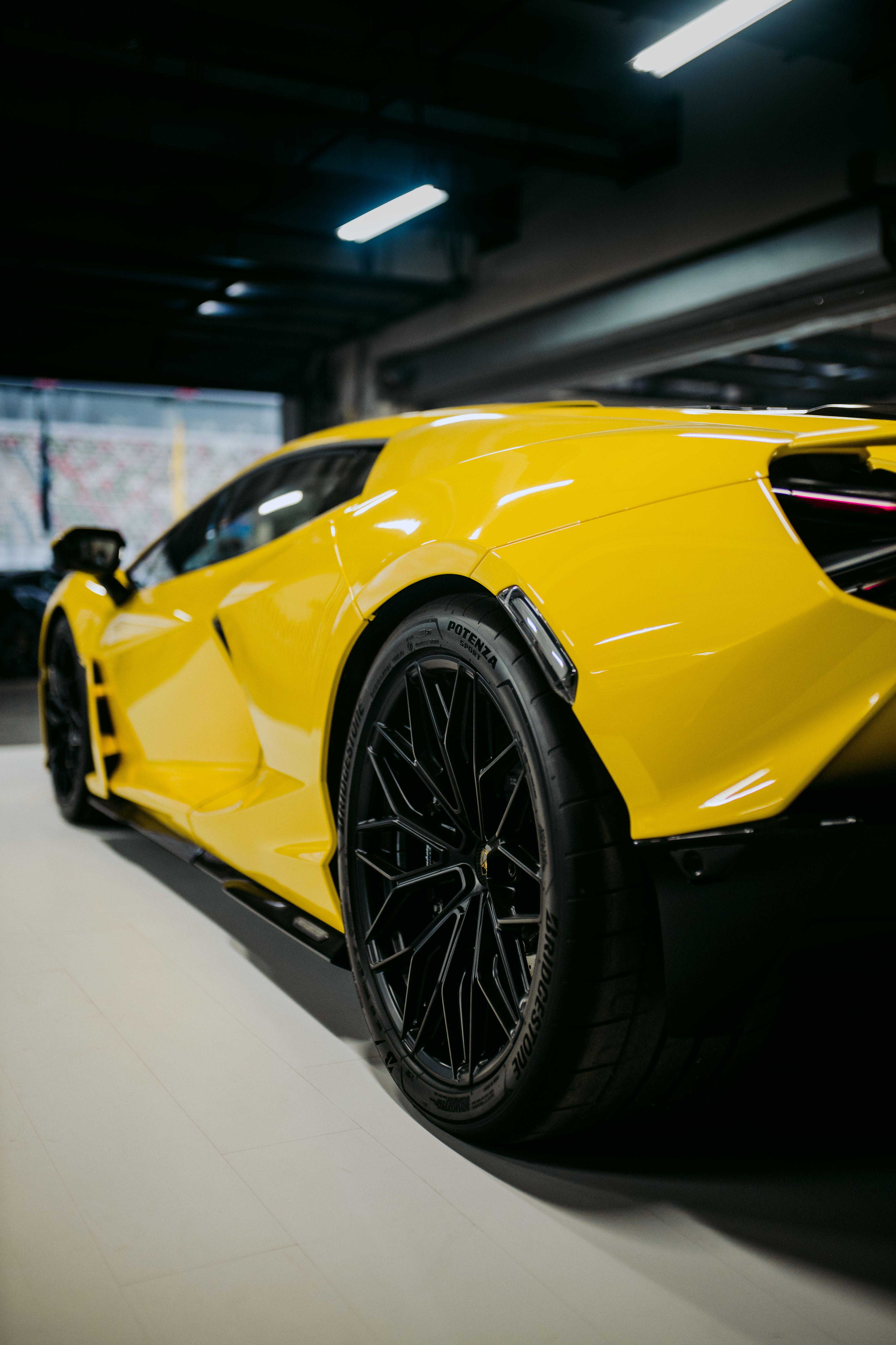 Vibrant Yellow Luxury Supercar in Indoor Setting · Free Stock Photo