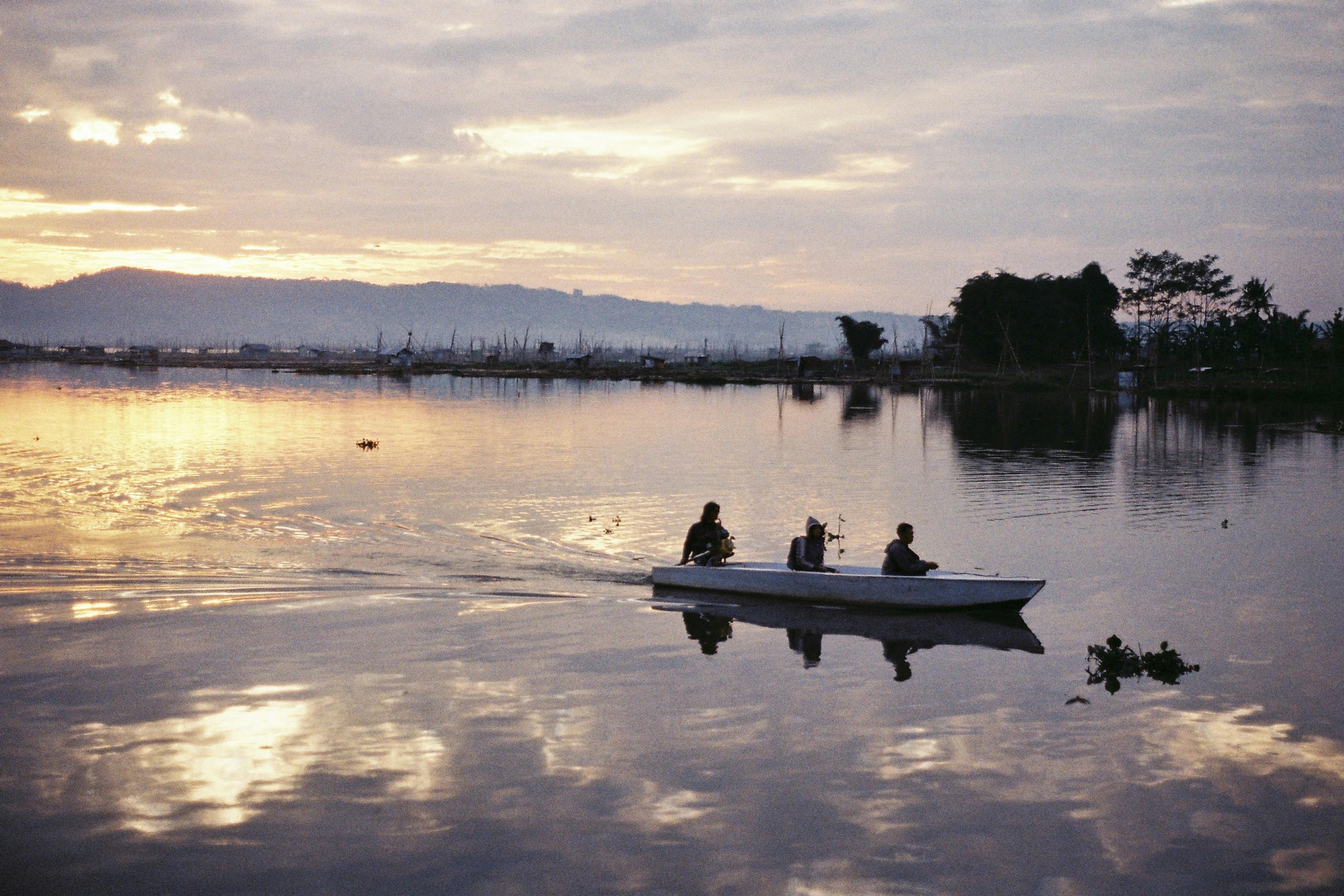 Serene Boat Ride at Sunrise on Central Java Lake · Free Stock Photo
