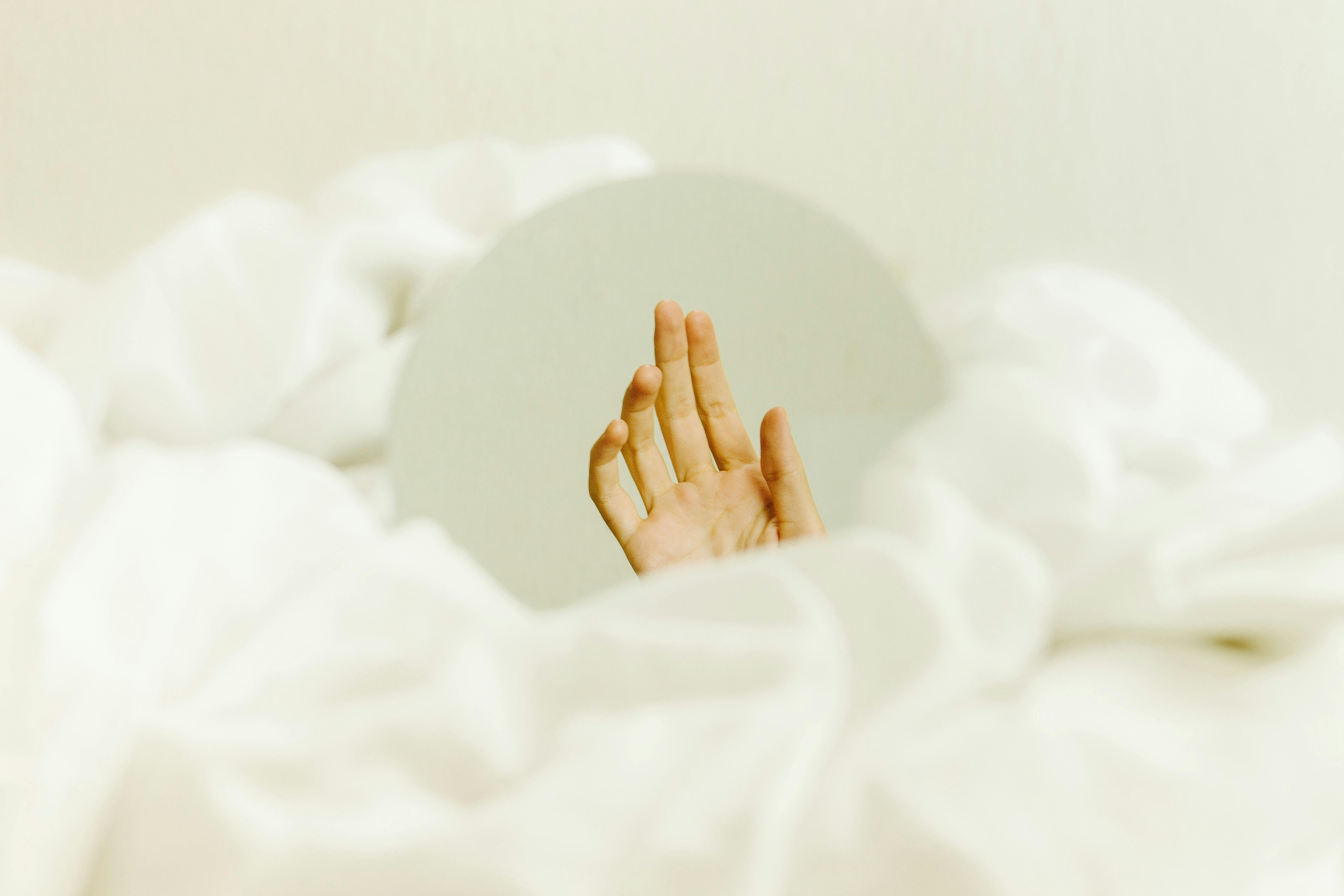 Serene Minimalist Hand Reflection in Mirror · Free Stock Photo