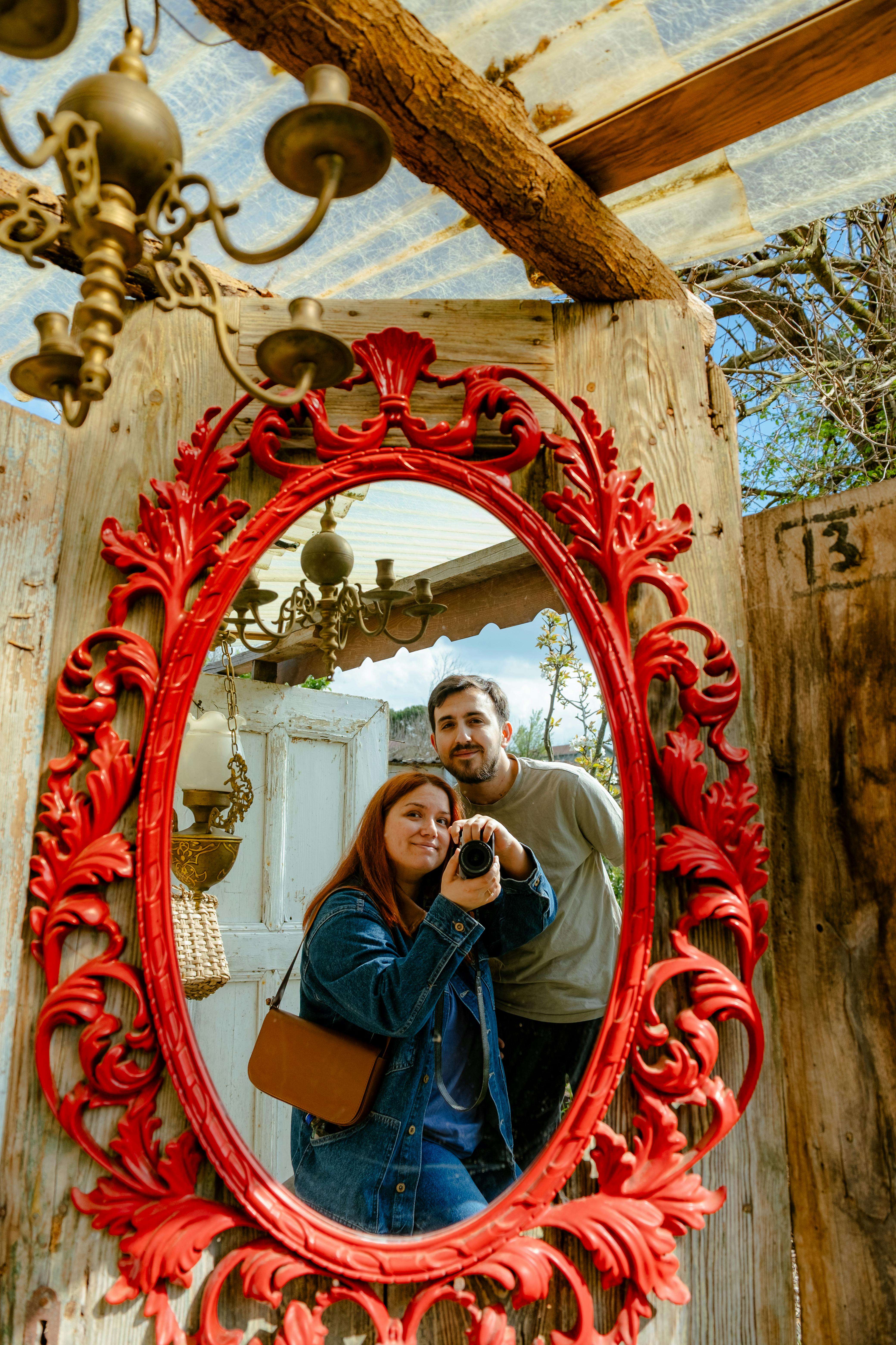Couple Reflection in Rustic Red Mirror Outdoors · Free Stock Photo