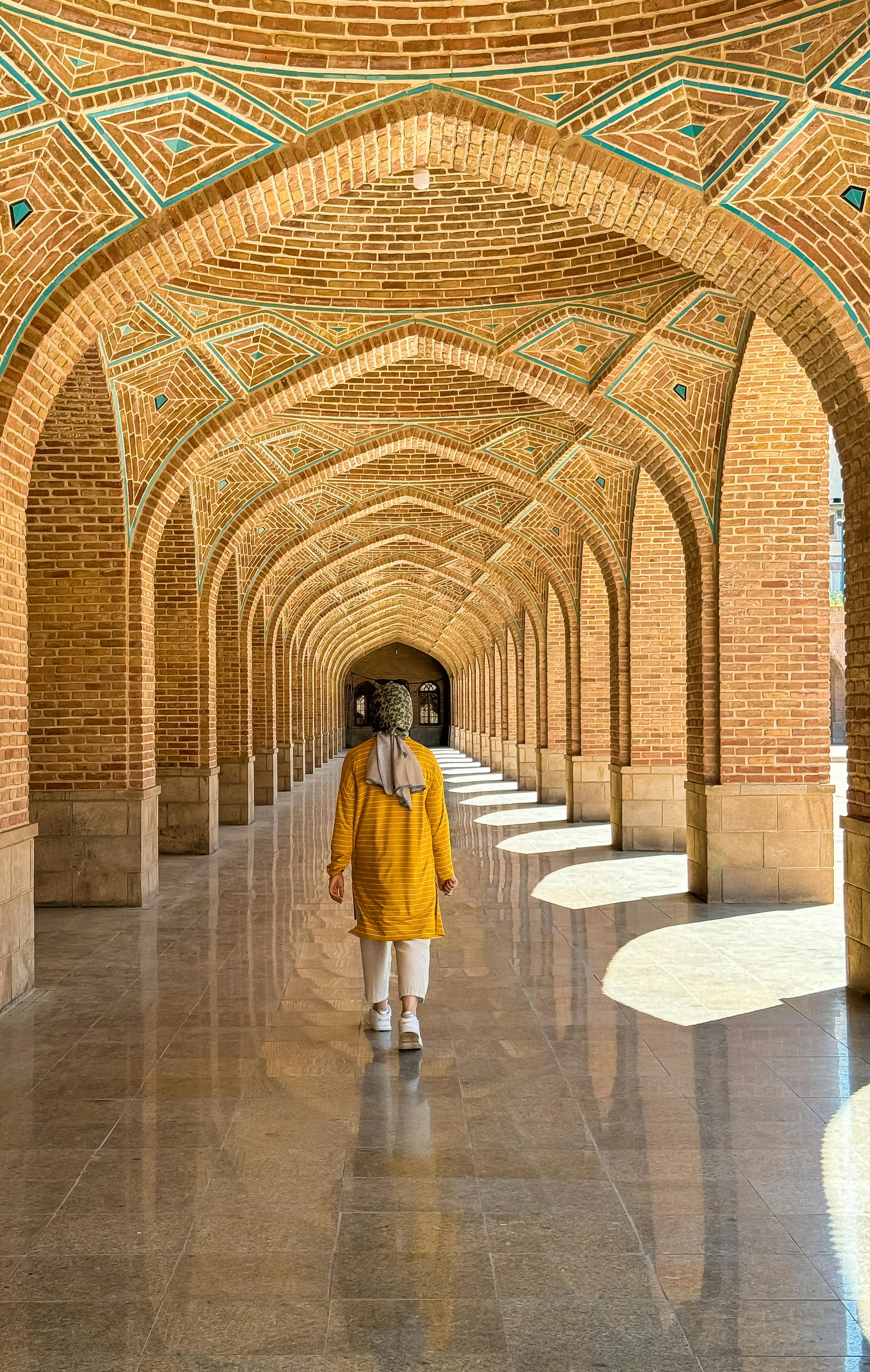 Serene Walk through Historic Tabriz Mosque Archway · Free Stock Photo