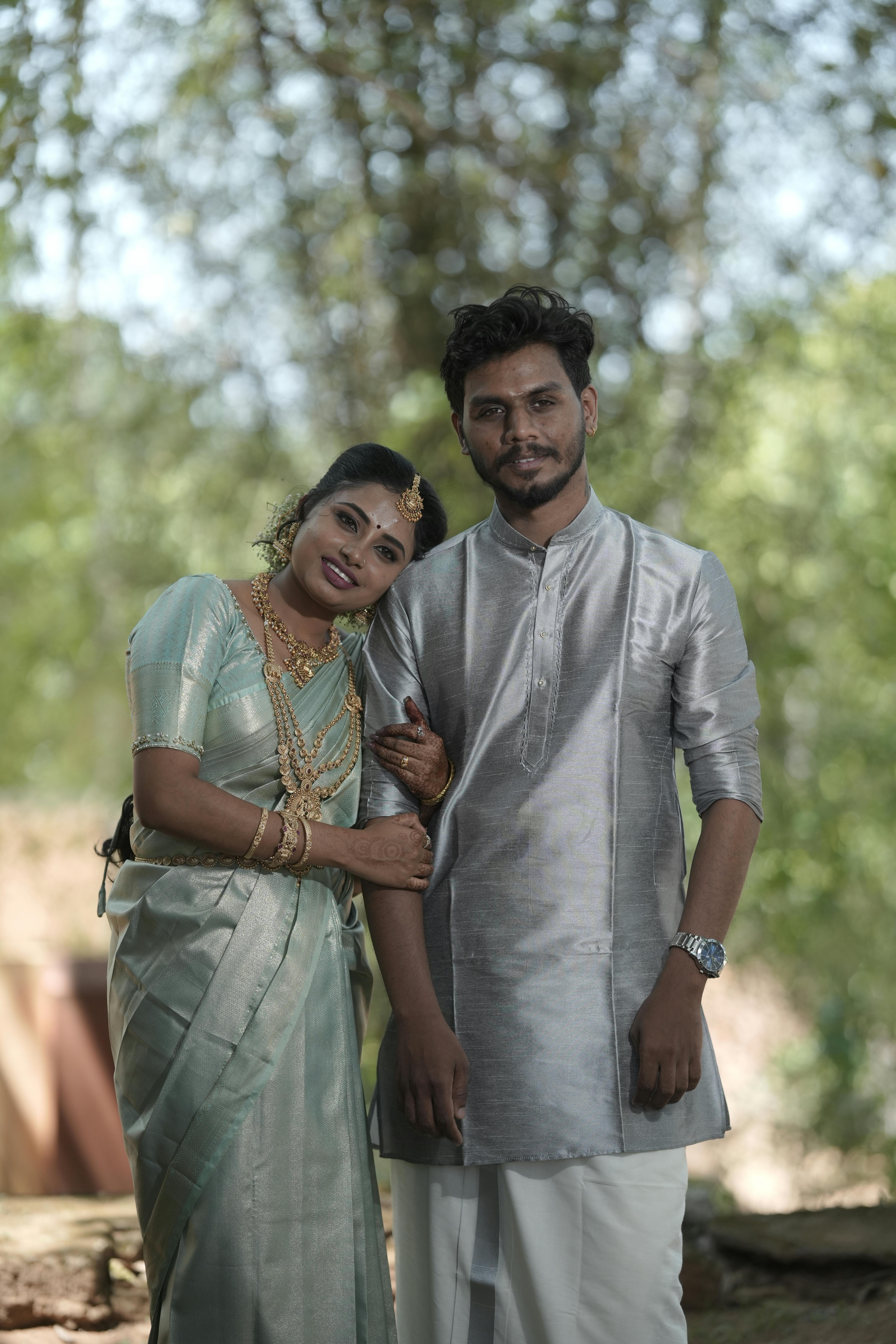 Elegant Couple in Traditional Attire Outdoors · Free Stock Photo