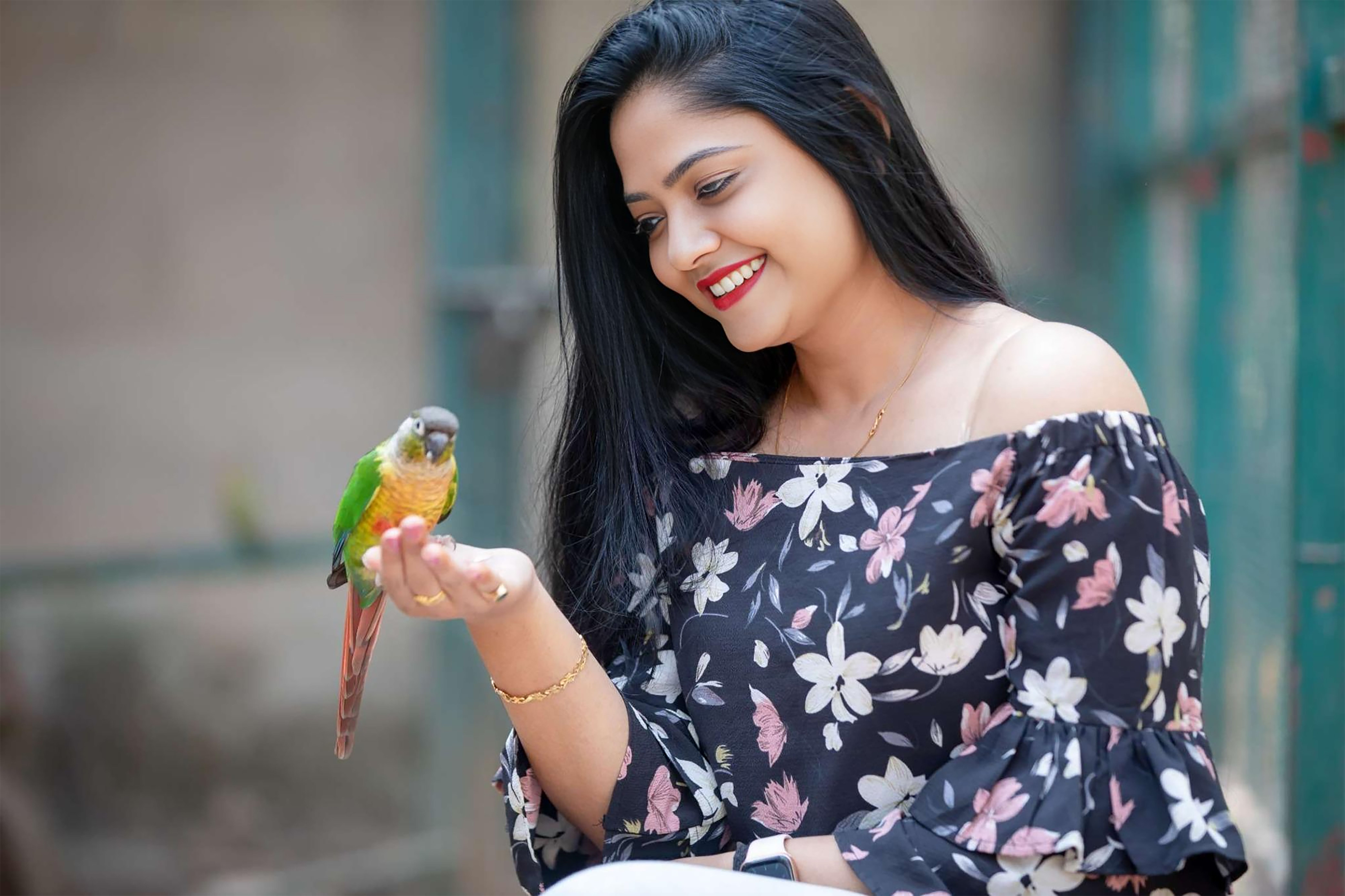 Woman Smiling at a Colorful Parrot · Free Stock Photo