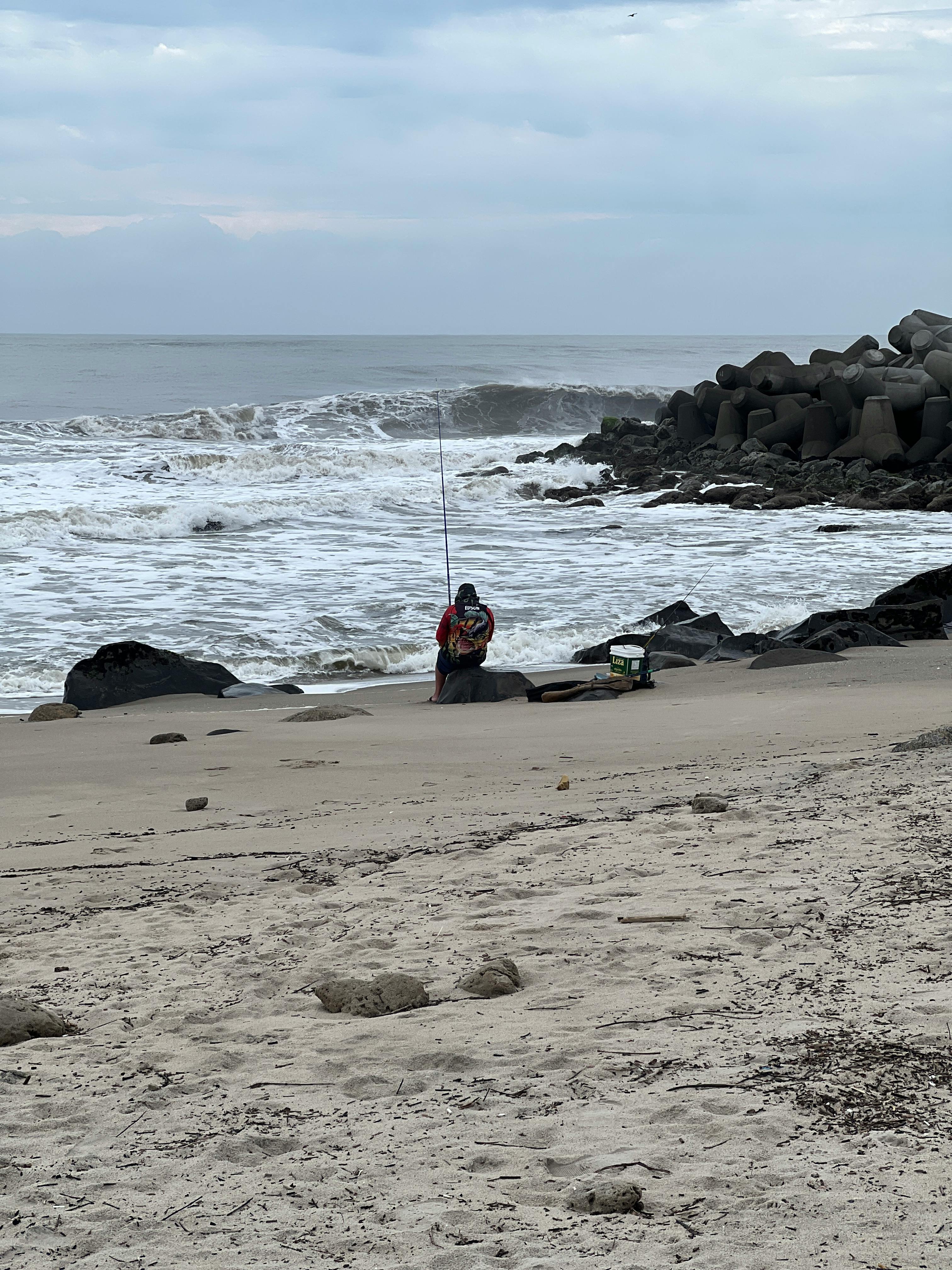 Fisherman Angling on Rocky Brazilian Beach · Free Stock Photo