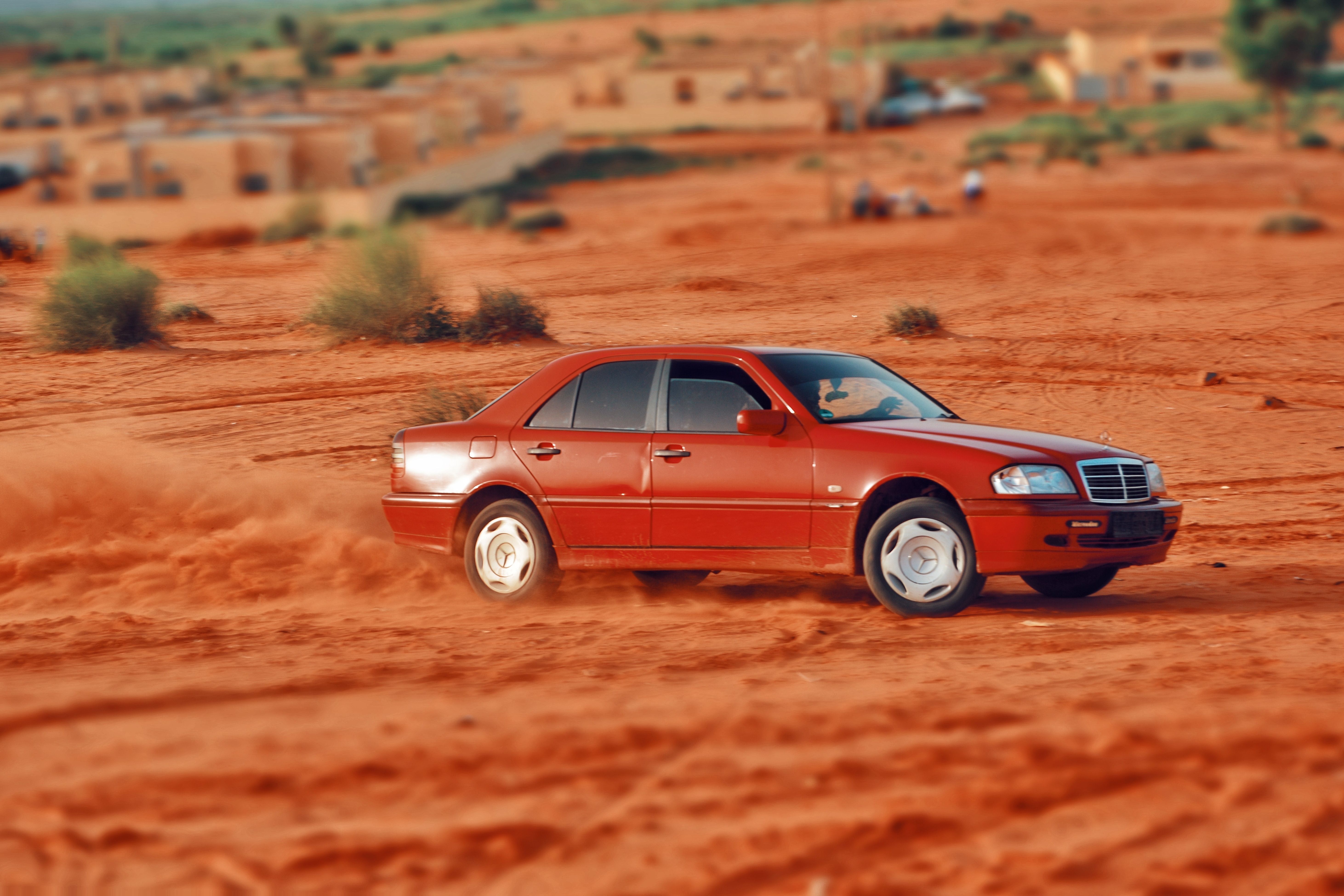 Red Car Drifting on Desert Terrain at Daytime · Free Stock Photo