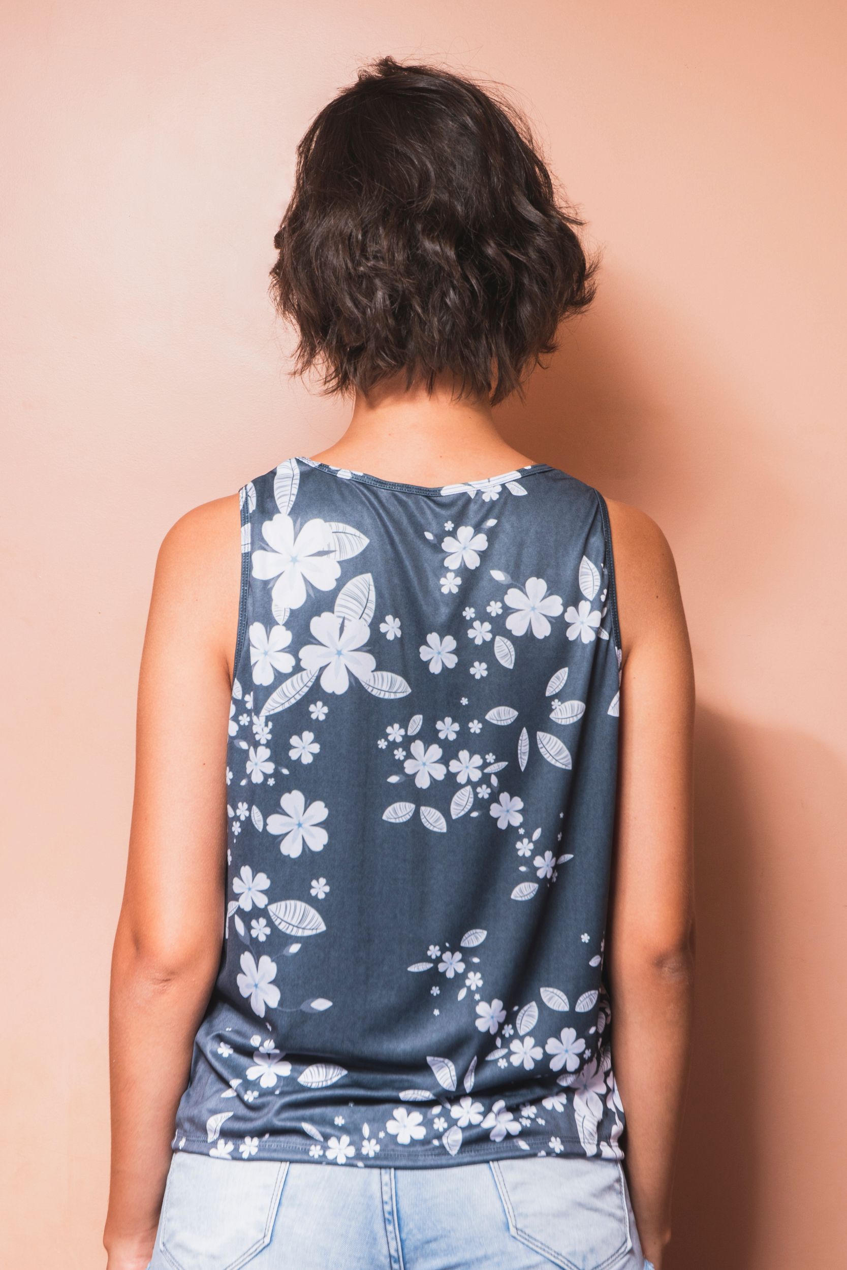 Back View of Person in Floral Top Against Peach Background · Free Stock ...