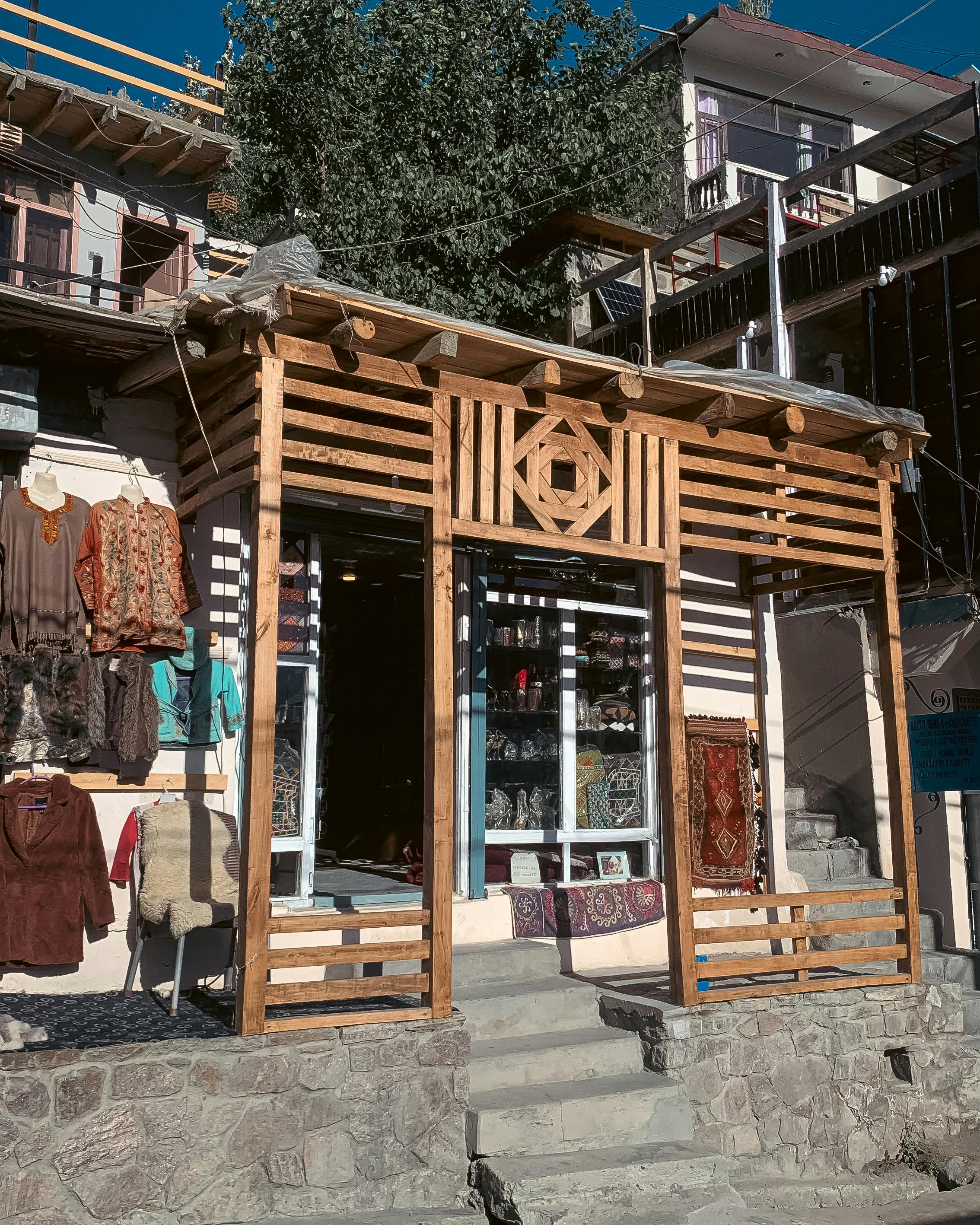 Rustic Storefront with Handcrafted Clothing Display · Free Stock Photo