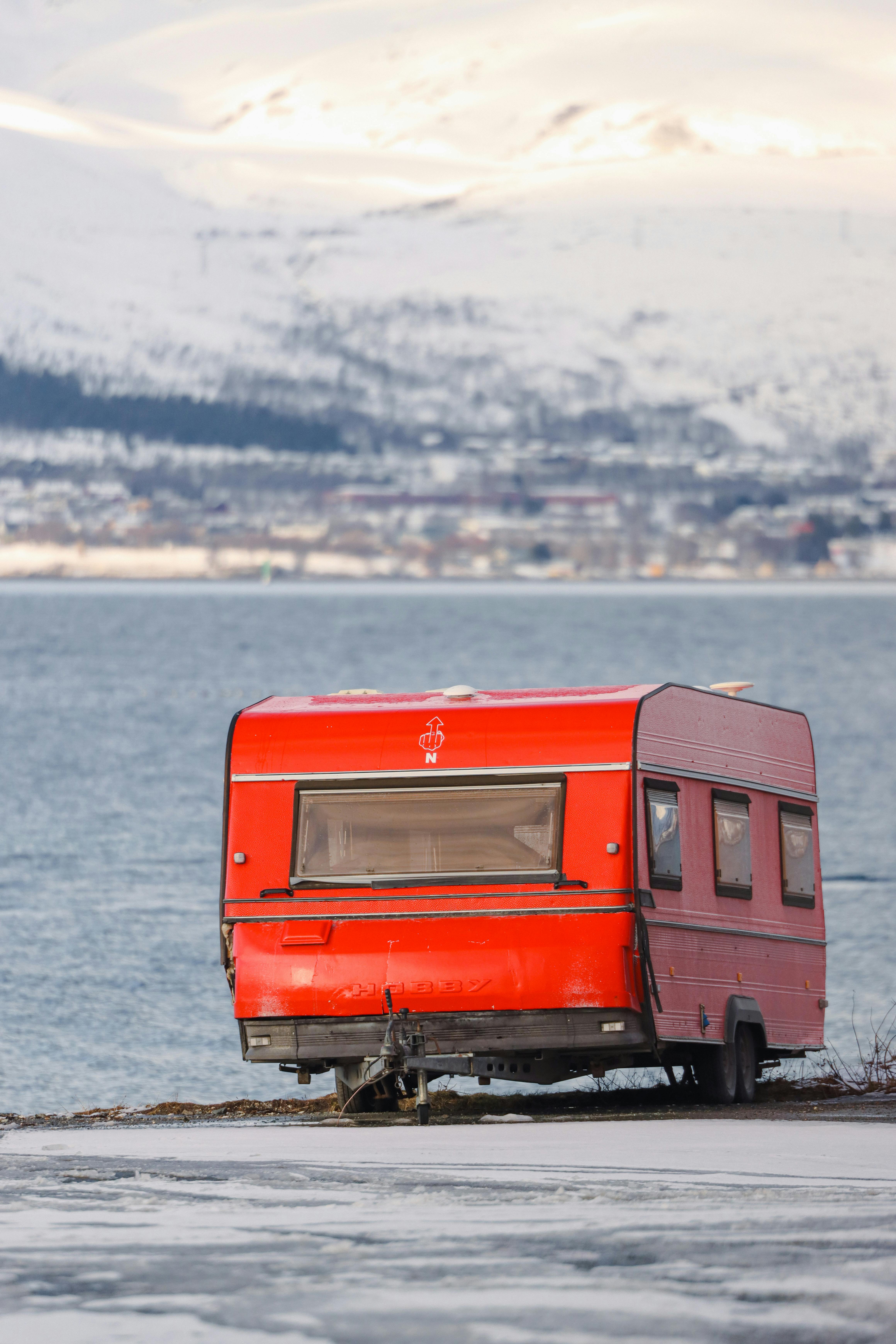 Red Caravan by the Scenic Norwegian Coast · Free Stock Photo