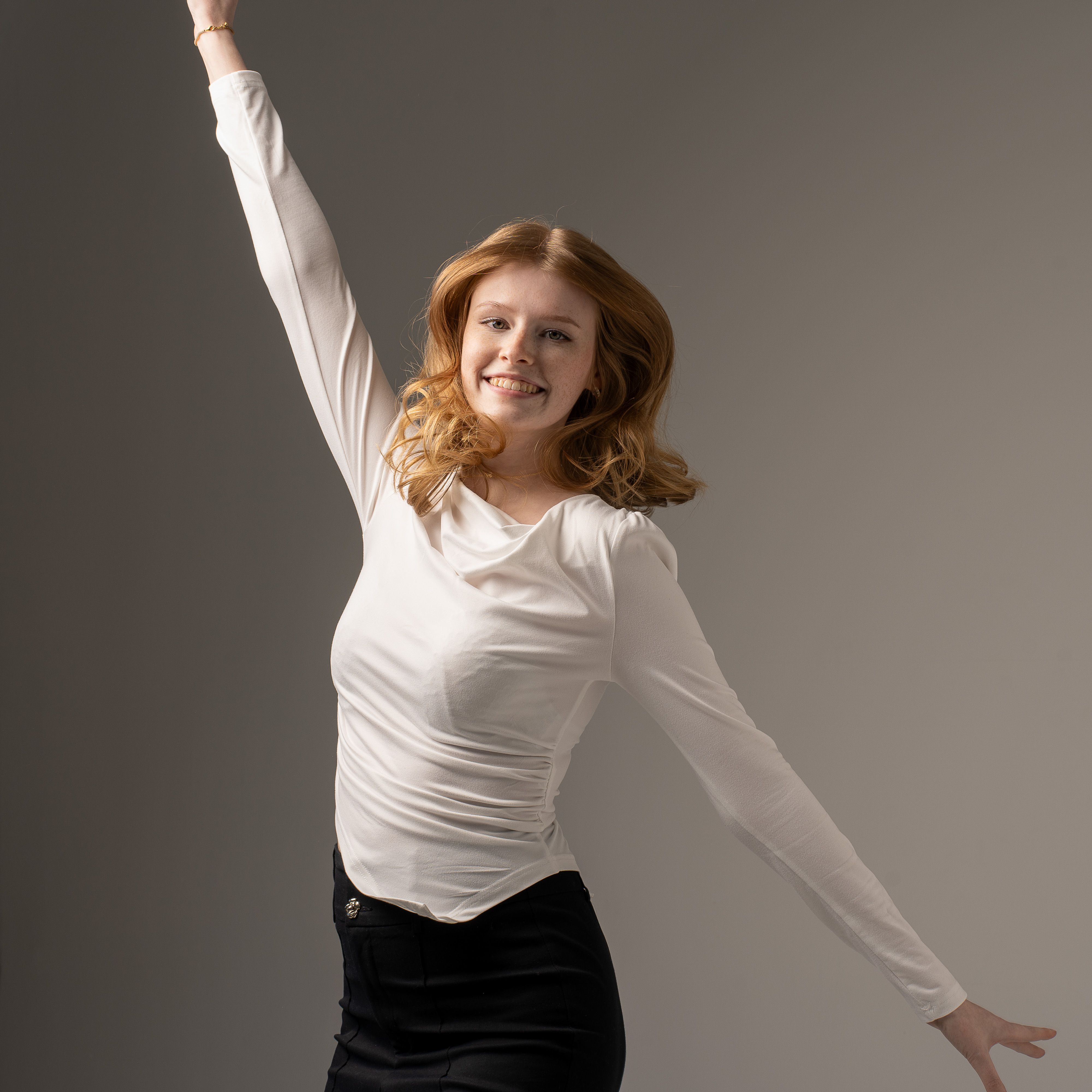 Cheerful Woman in Dynamic Pose with White Blouse · Free Stock Photo