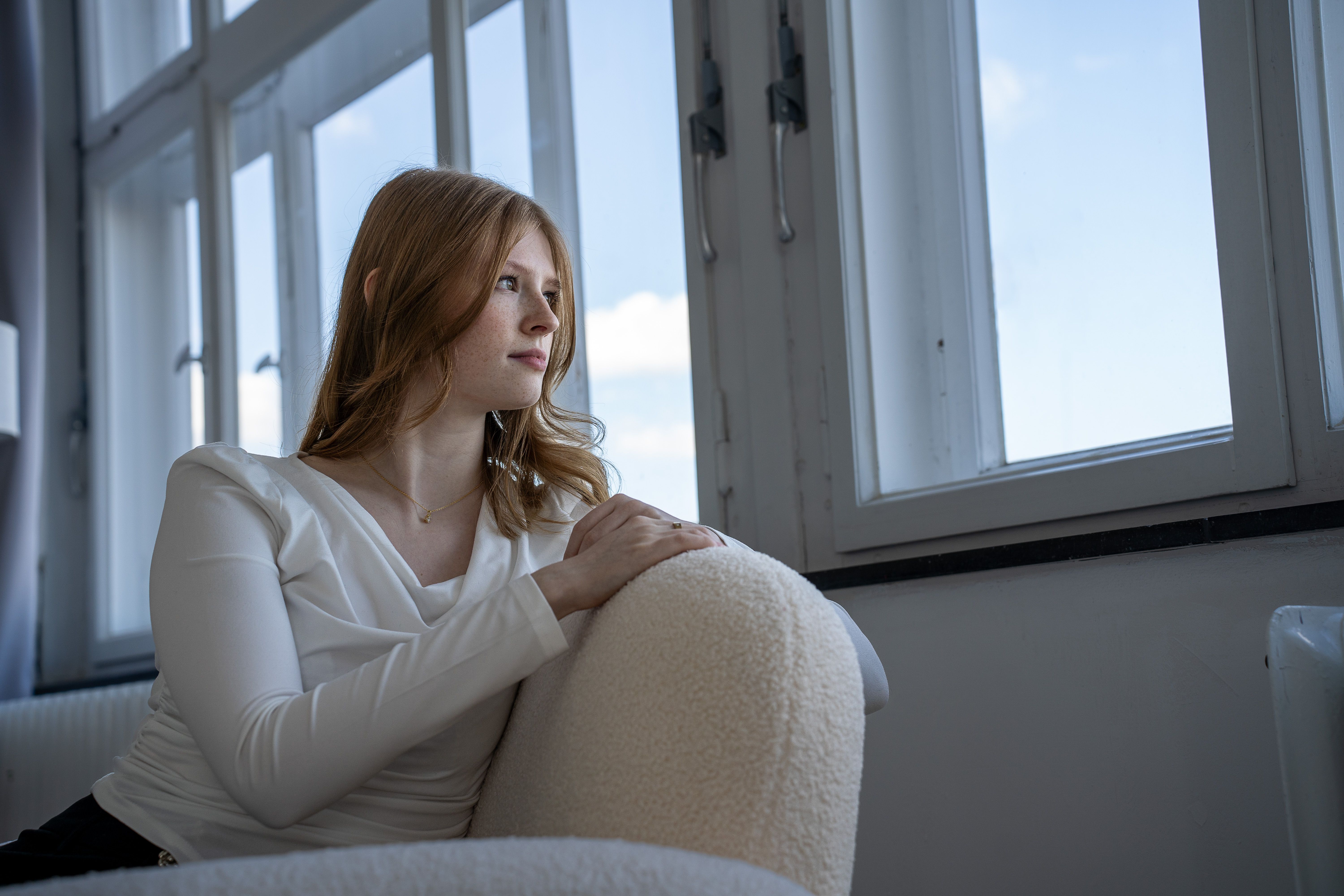Photography of Woman Sitting on Chair Near Window · Free Stock Photo