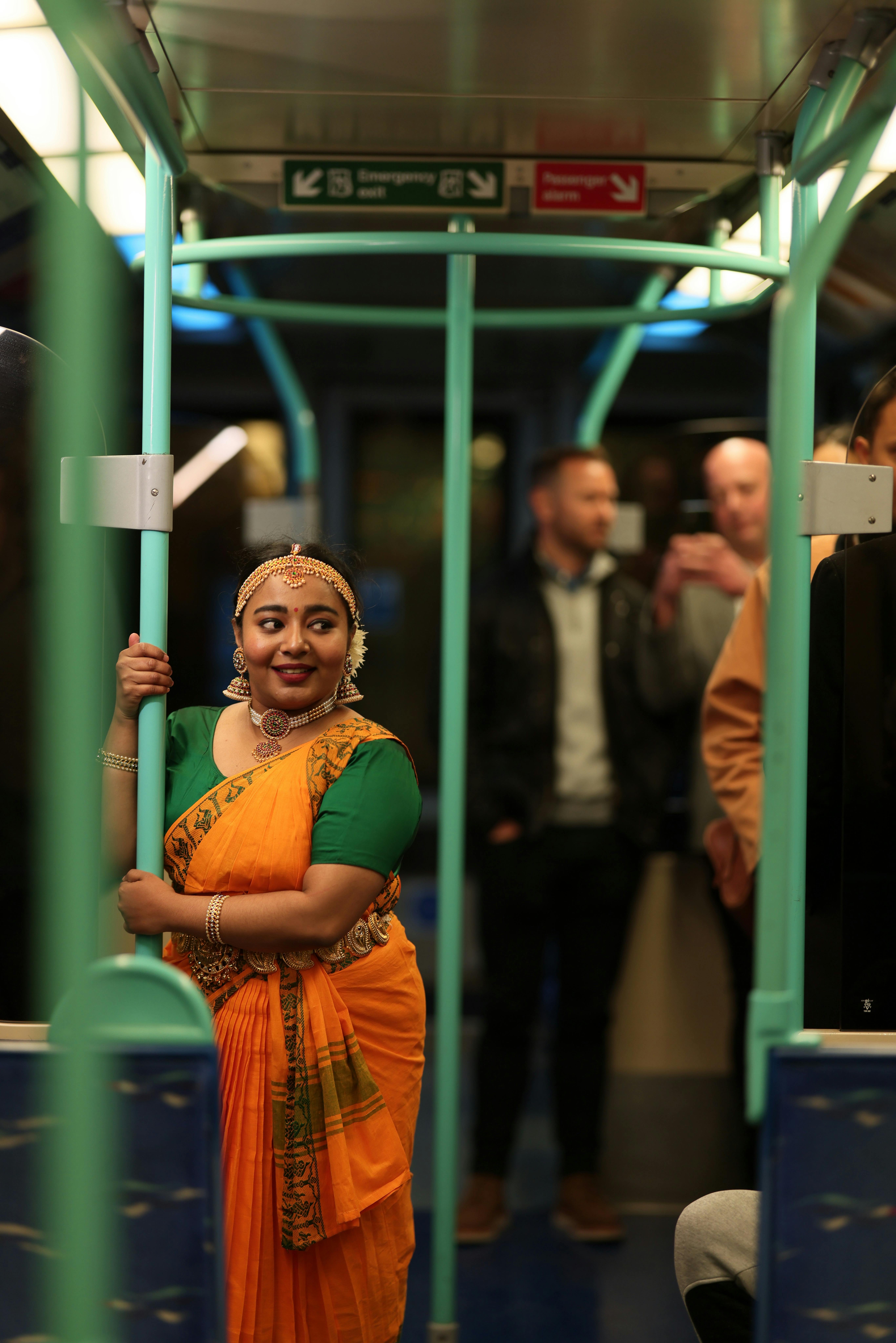 Colorful Traditional Attire in Modern Subway Setting · Free Stock Photo