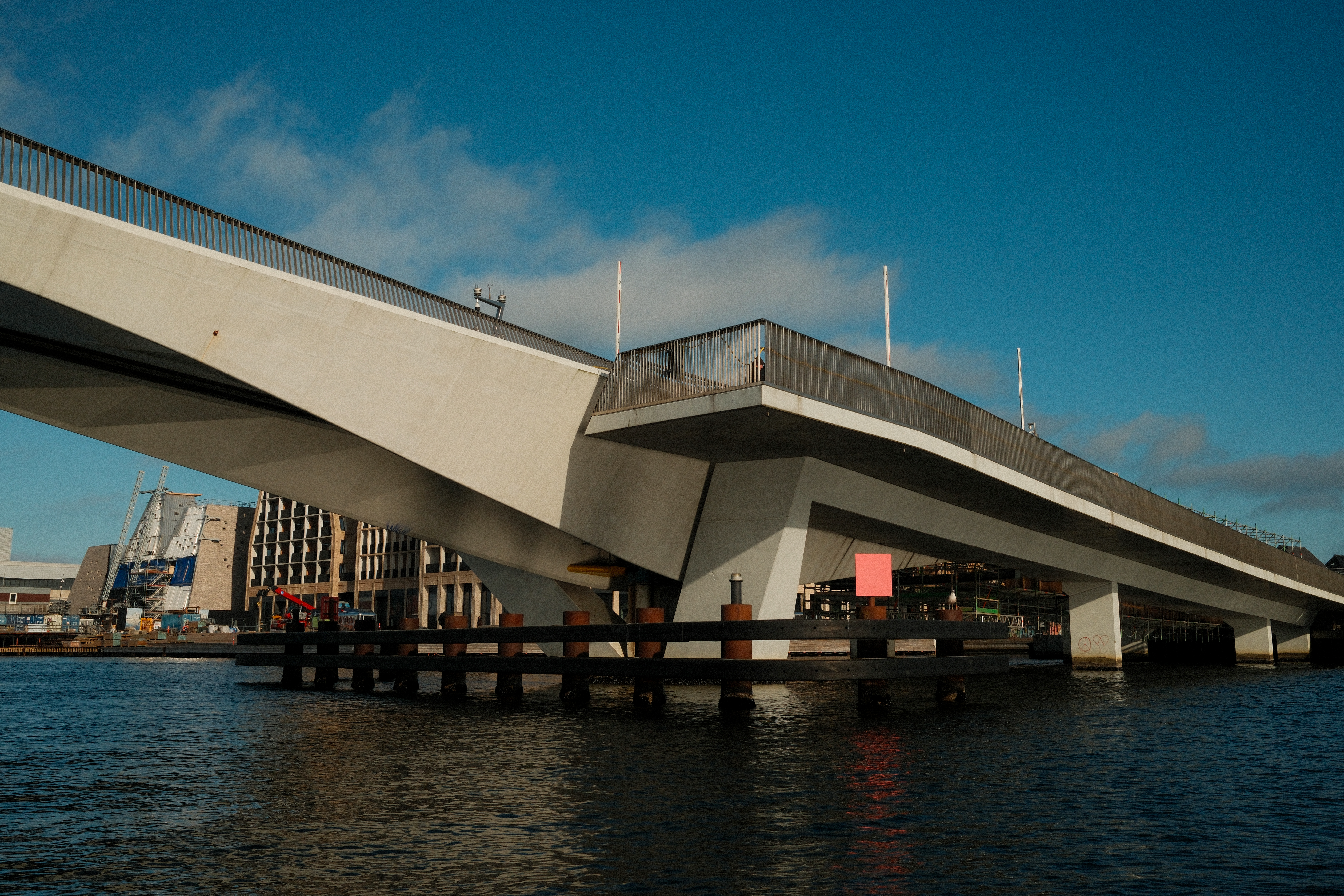Modern Pedestrian Bridge Over Calm River Waters · Free Stock Photo