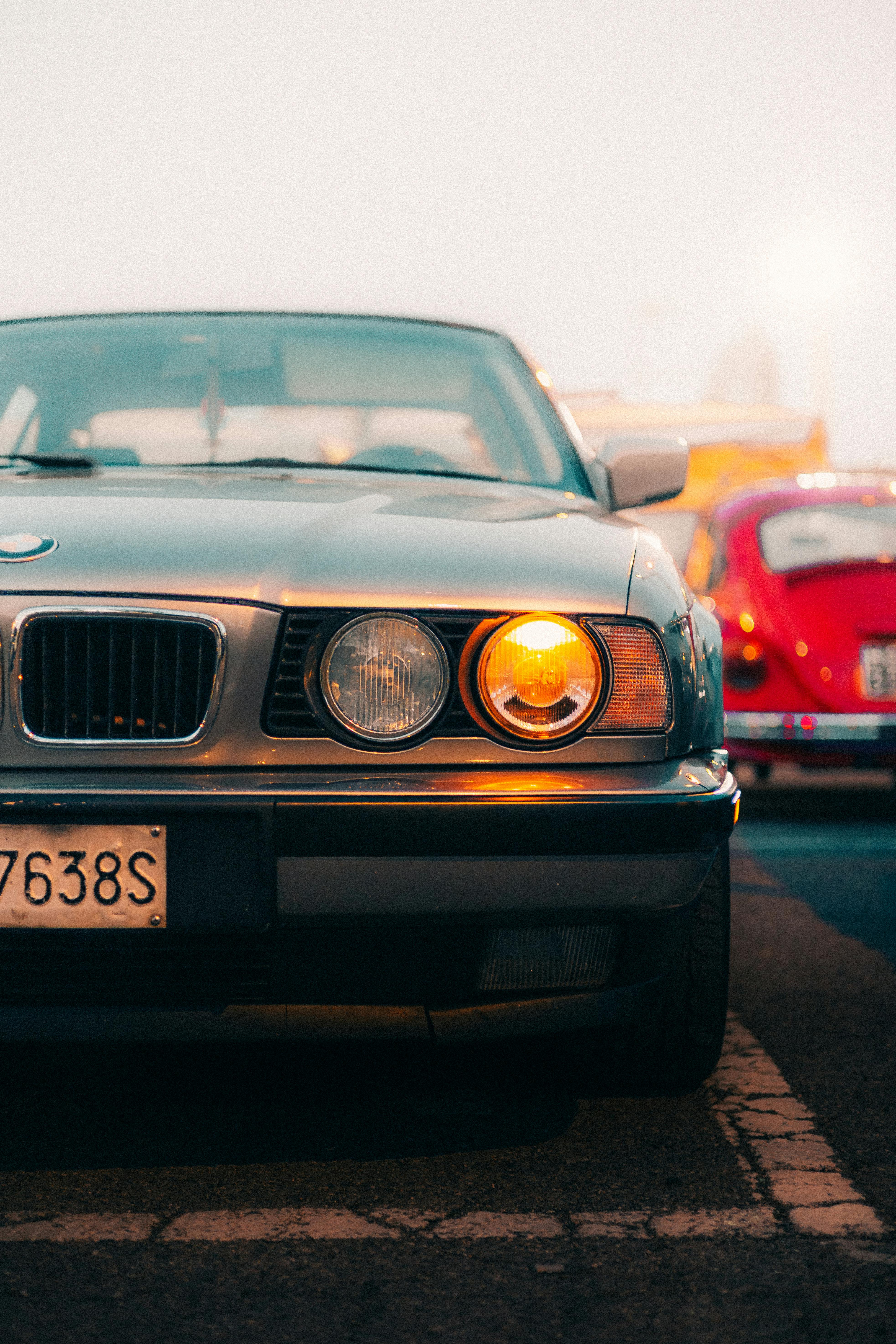 Classic Car with Headlight On at Sunset · Free Stock Photo