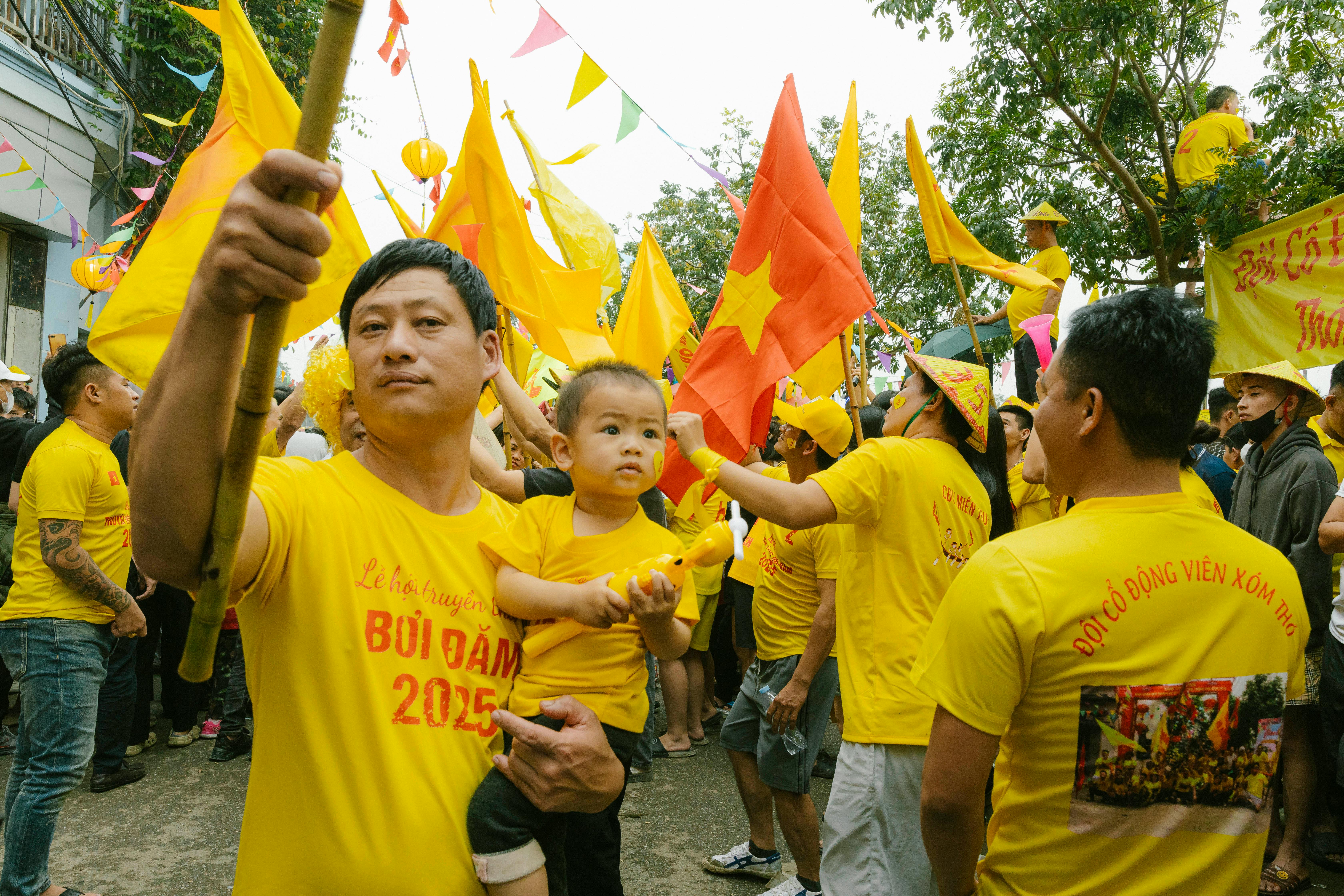 Vibrant Festival Parade with Flags and Crowd · Free Stock Photo
