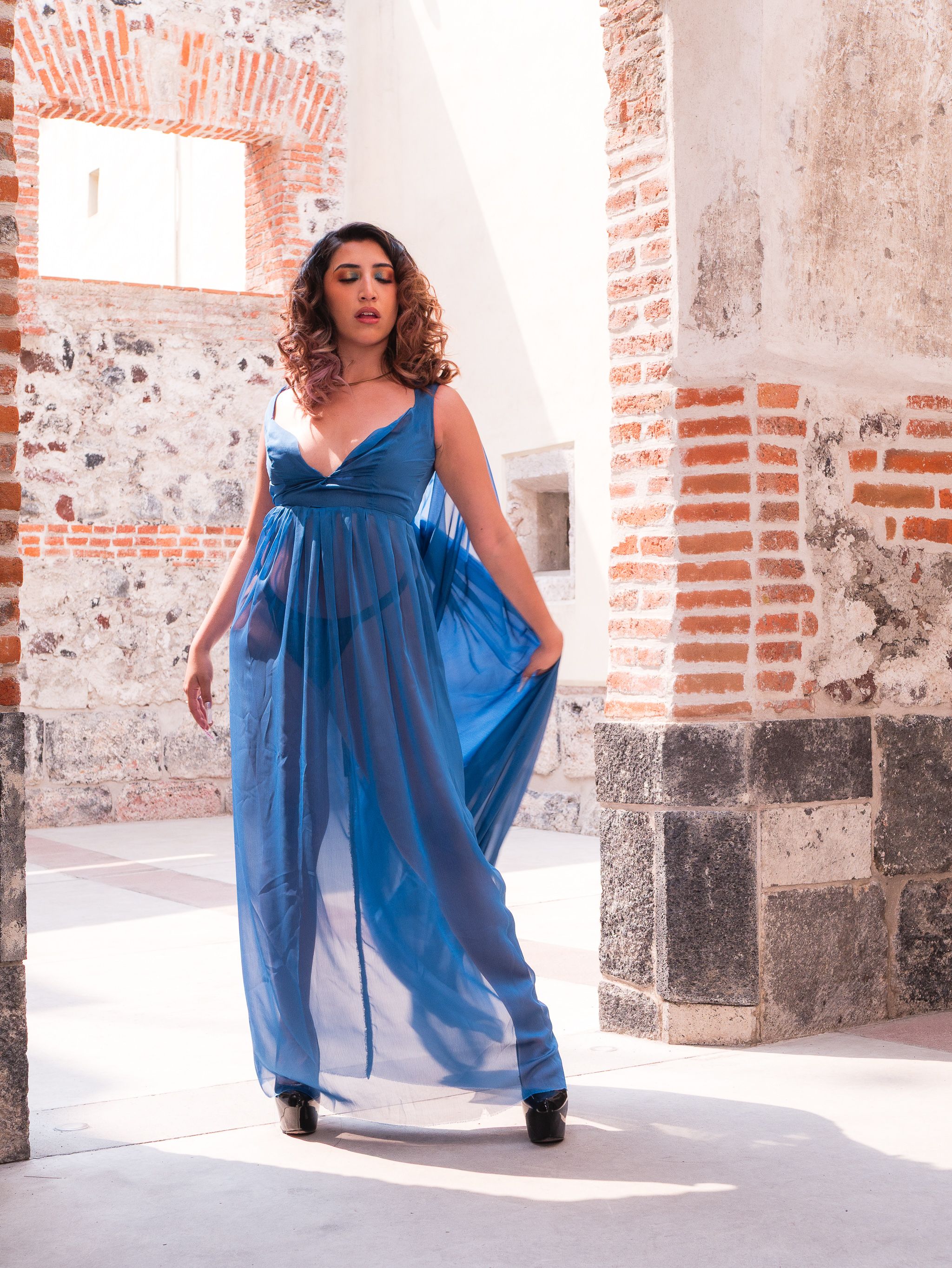 Elegant Model in Flowing Blue Dress Outdoors · Free Stock Photo