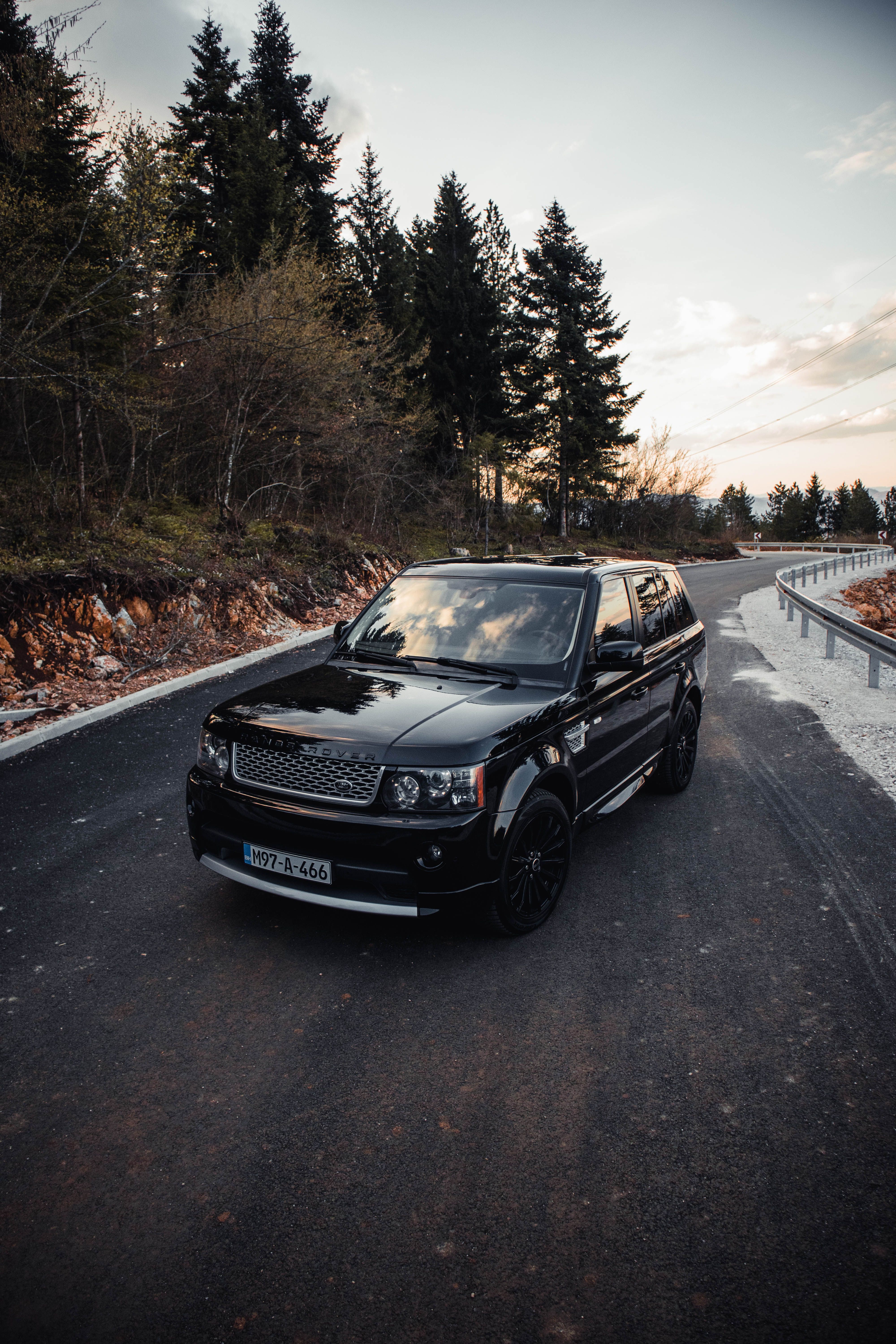 Black SUV Driving on Sarajevo's Scenic Highland Road · Free Stock Photo