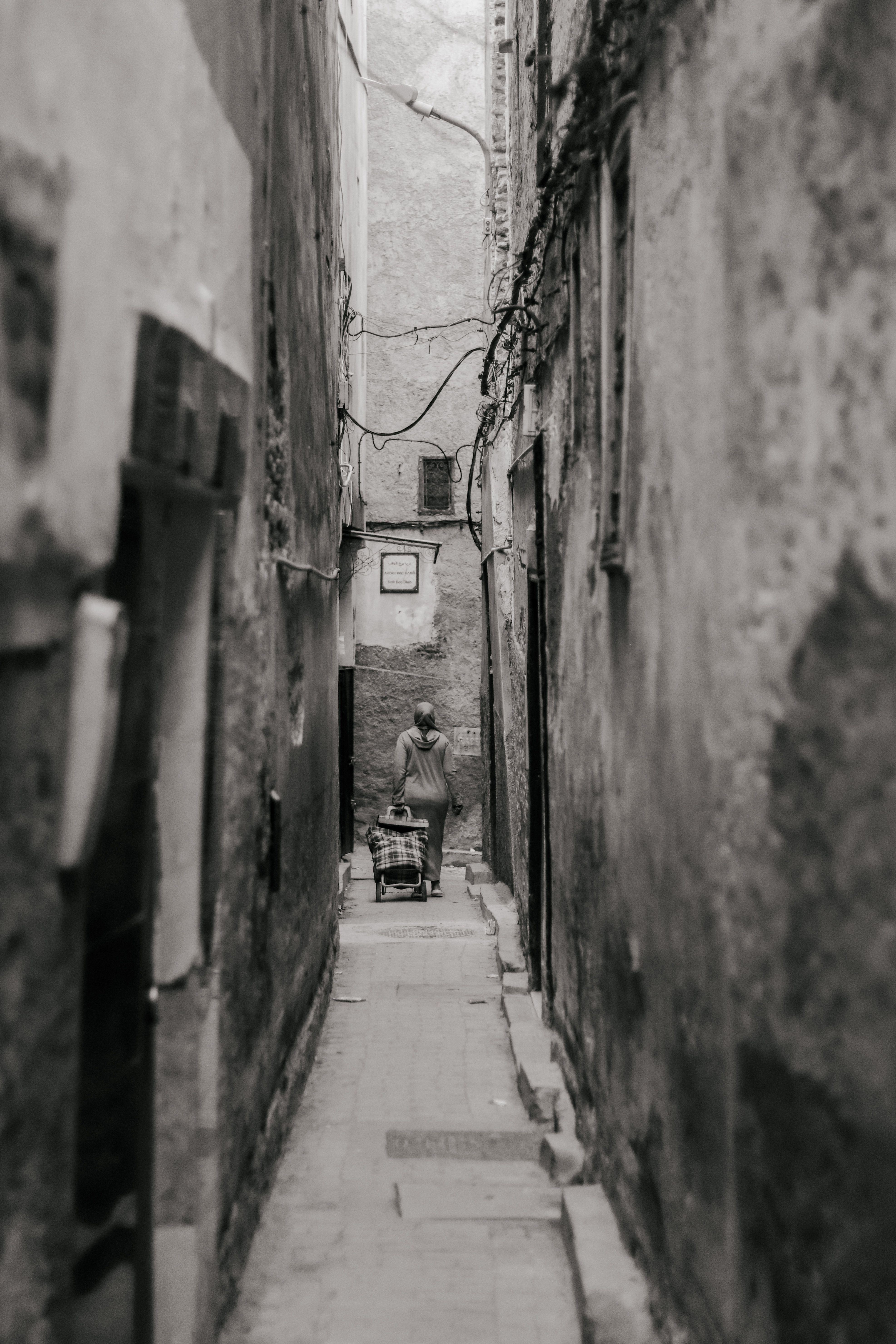Narrow Alleyway with Person Pushing Cart · Free Stock Photo