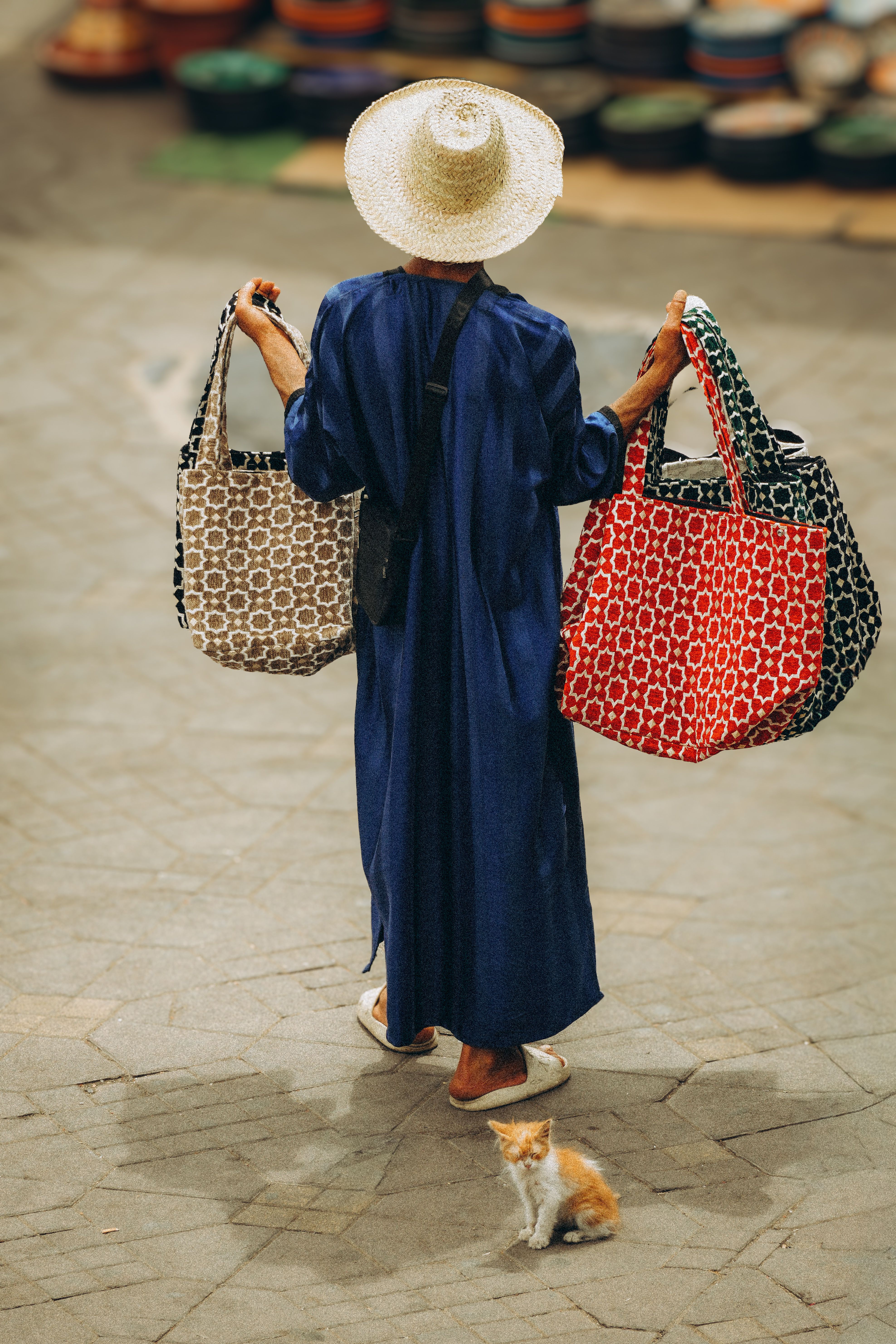 Woman with Colorful Bags in Marrakech Market · Free Stock Photo