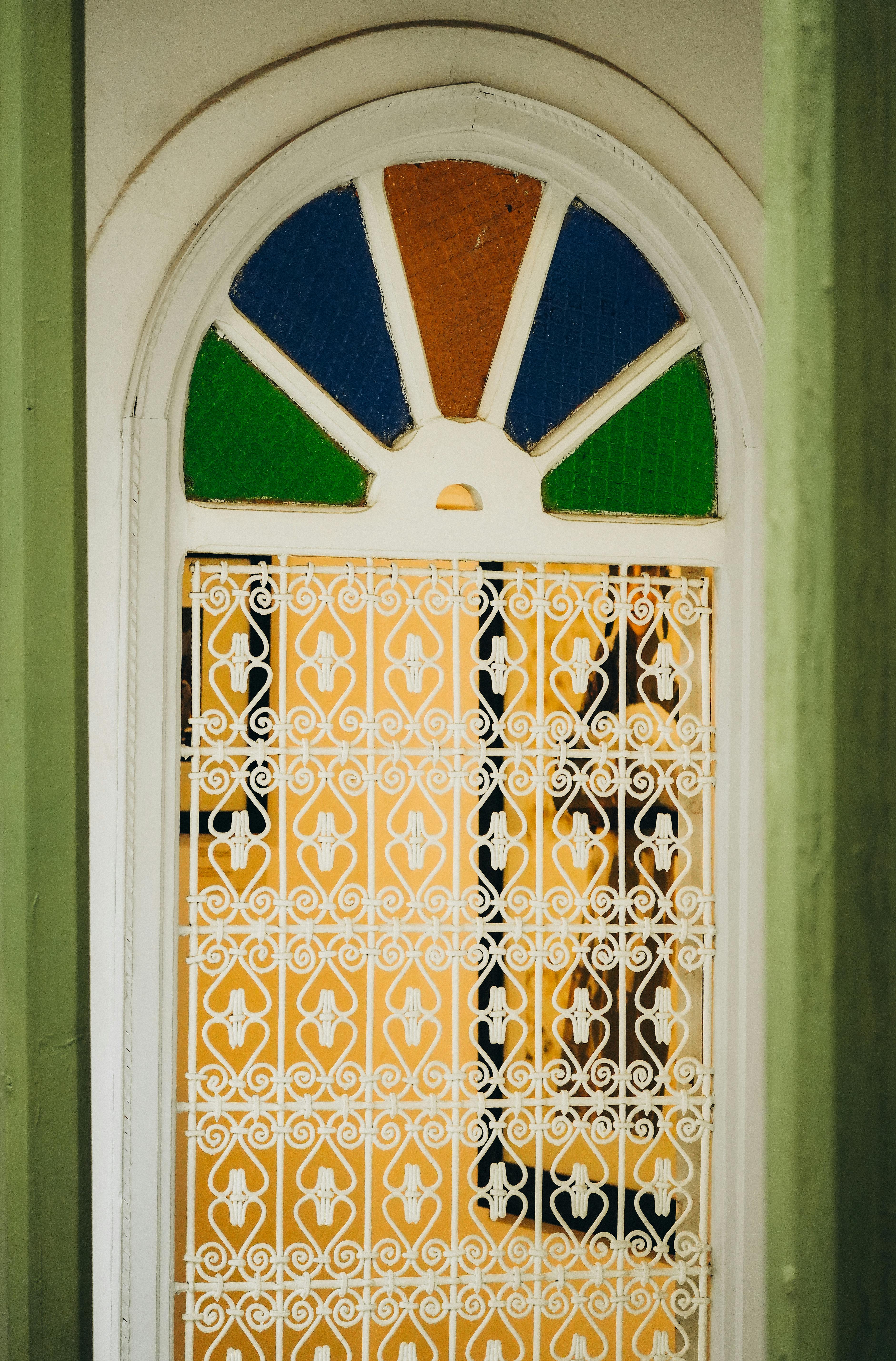 Colorful Moroccan Arched Window with Iron Grill · Free Stock Photo