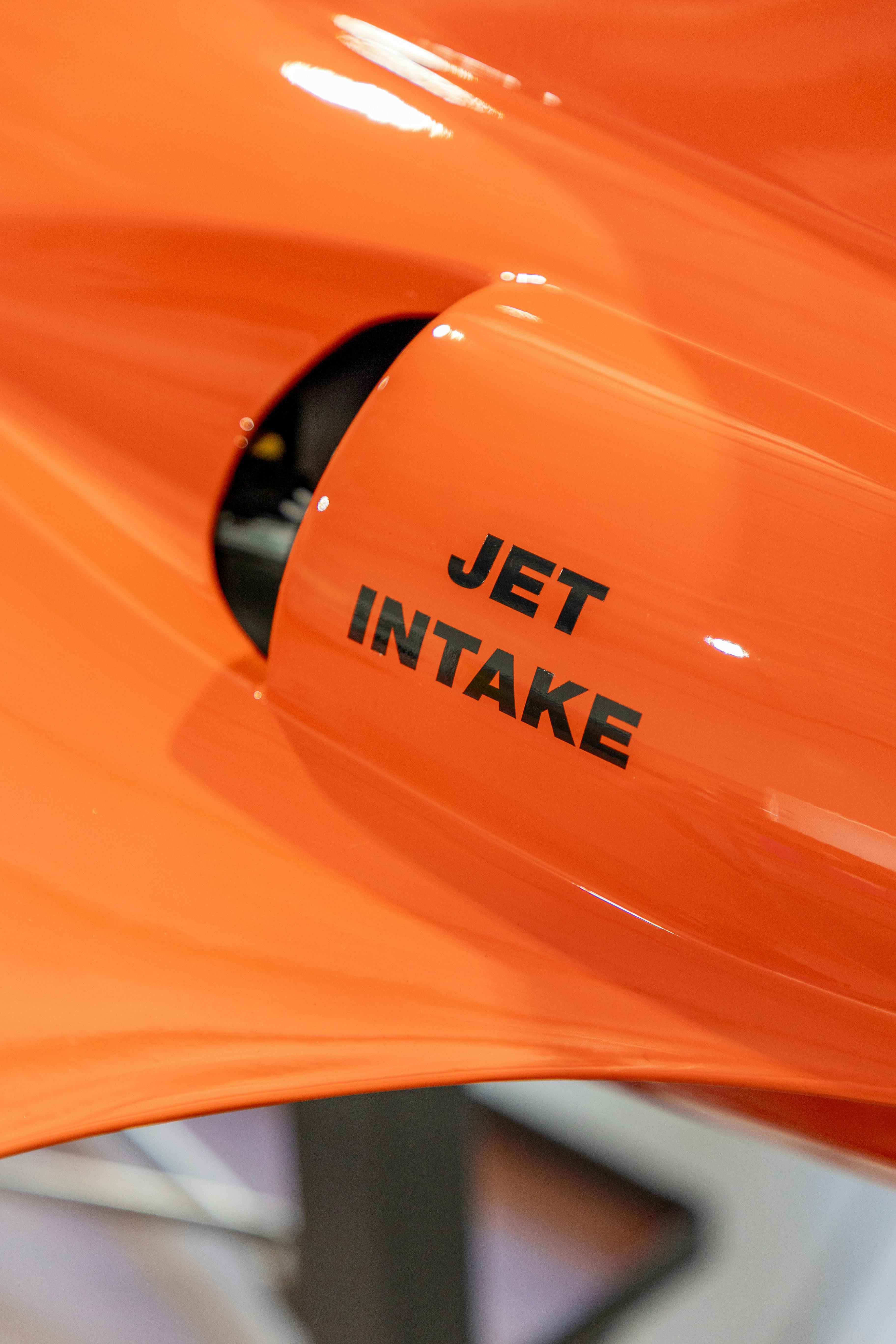 Close-Up of Orange Jet Intake with Text · Free Stock Photo